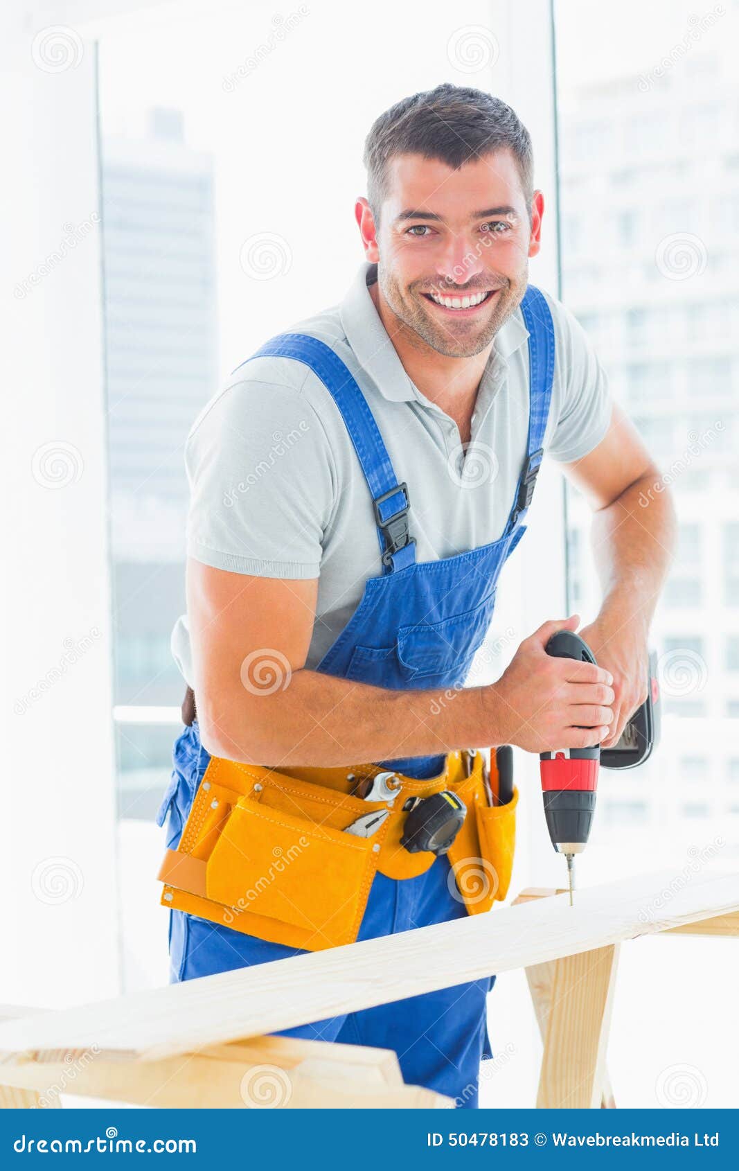 Happy Handyman Drilling Plank in Office Stock Image - Image of drill ...