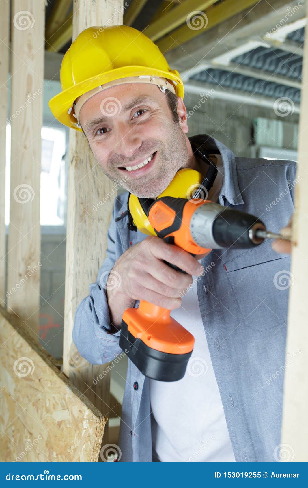 Happy Handyman Drilling Wall Stock Image - Image of contractor, looking ...