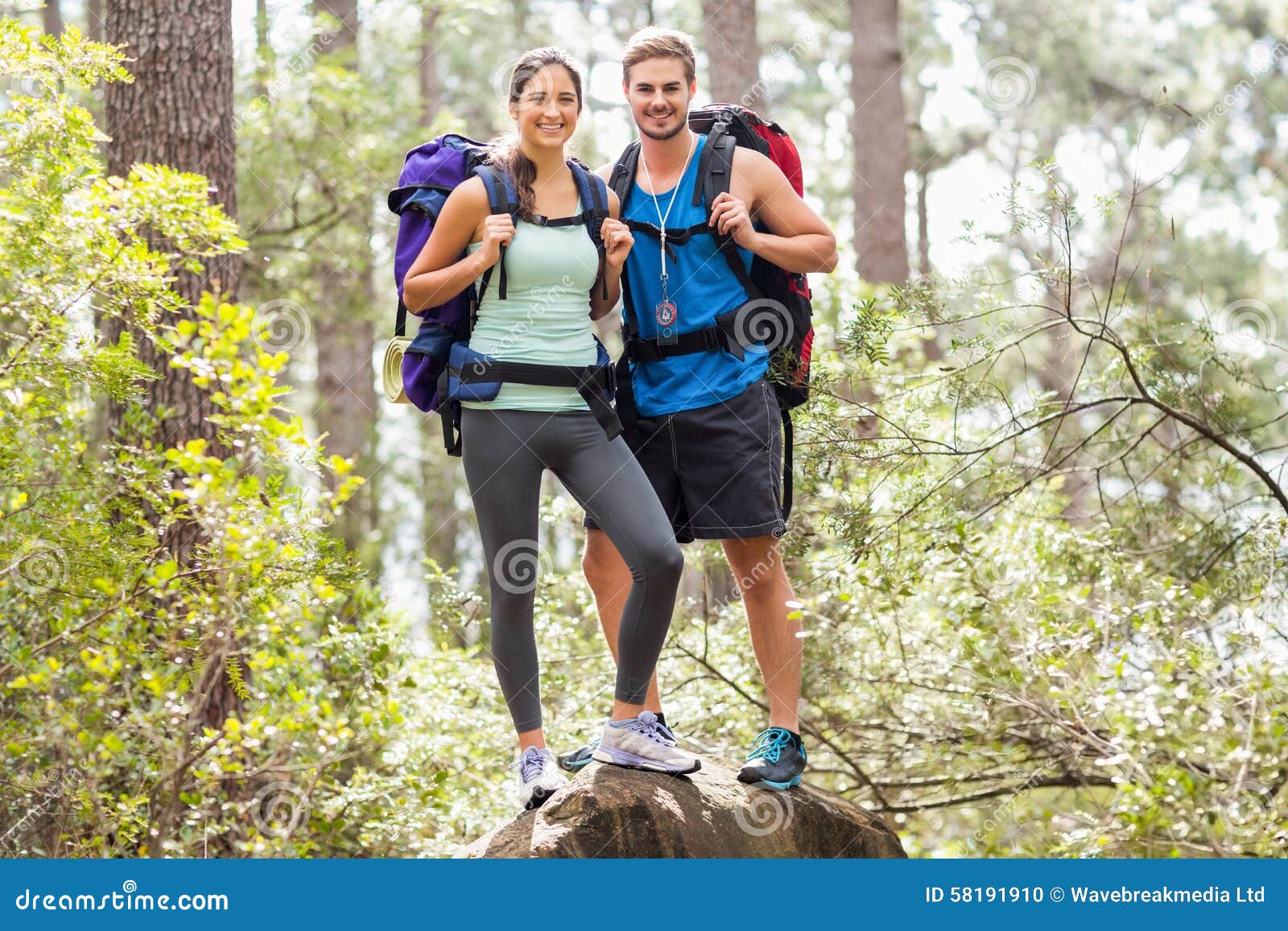 Happy Hikers Climbing on Rock and Smiling at Camera Stock Photo - Image ...