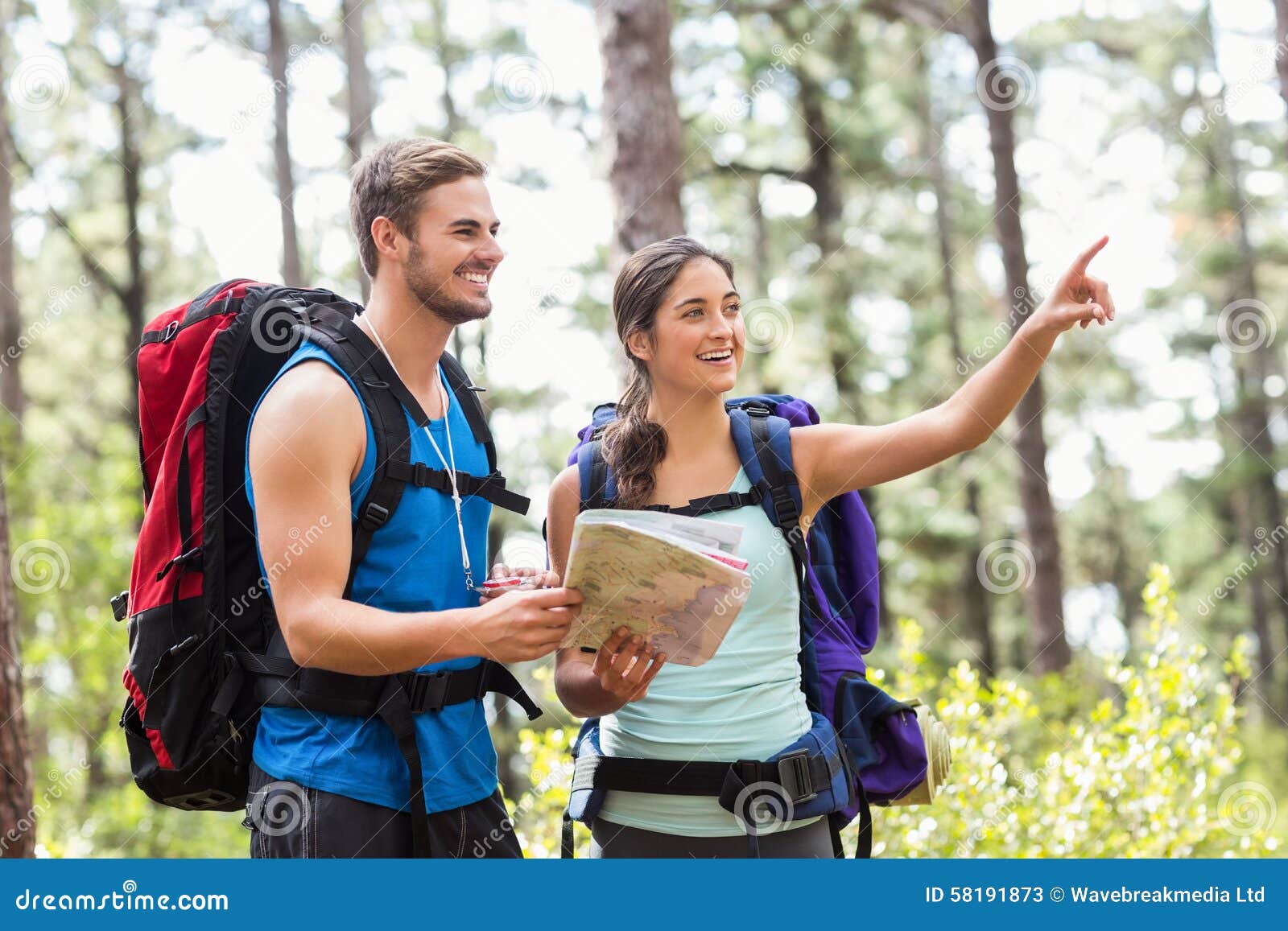 Happy Hikers Looking Away Holding Map and Compass Stock Image - Image ...