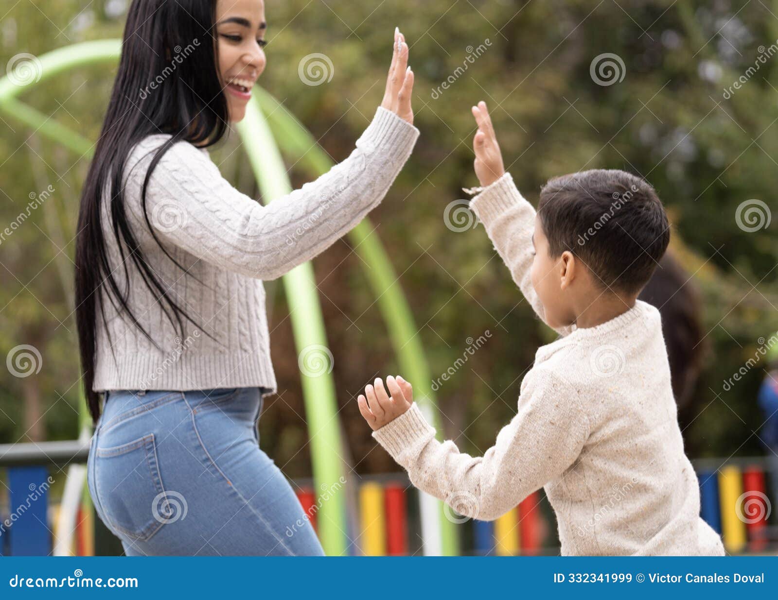 Happy Hispanic Mother and Son Giving High Five Outdoors Stock Image ...