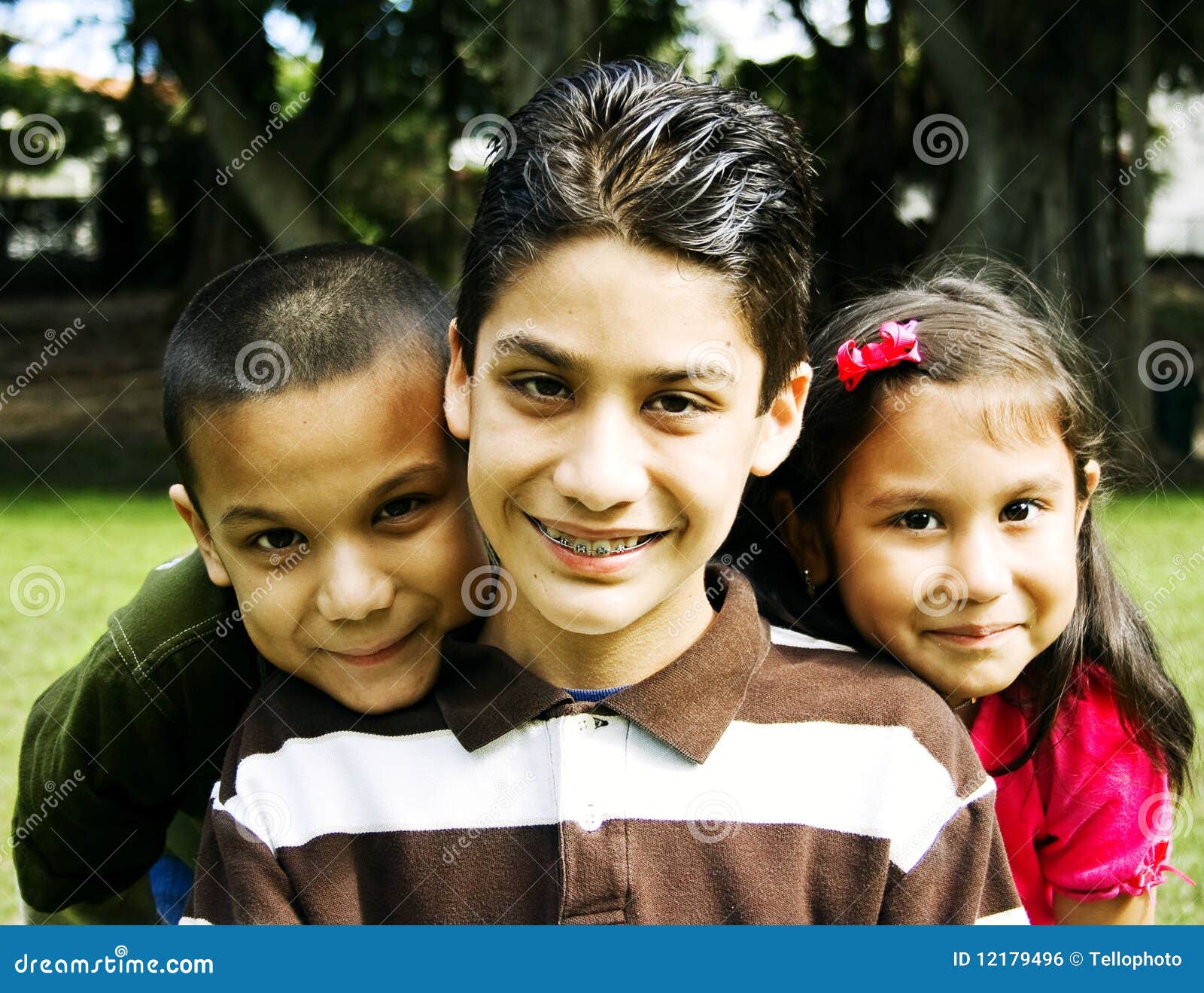 Happy Hispanic Siblings Together in Front of Tree Stock Photo - Image ...