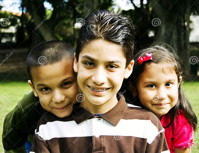 Happy Hispanic Siblings Together in Front of Tree Stock Photo - Image ...