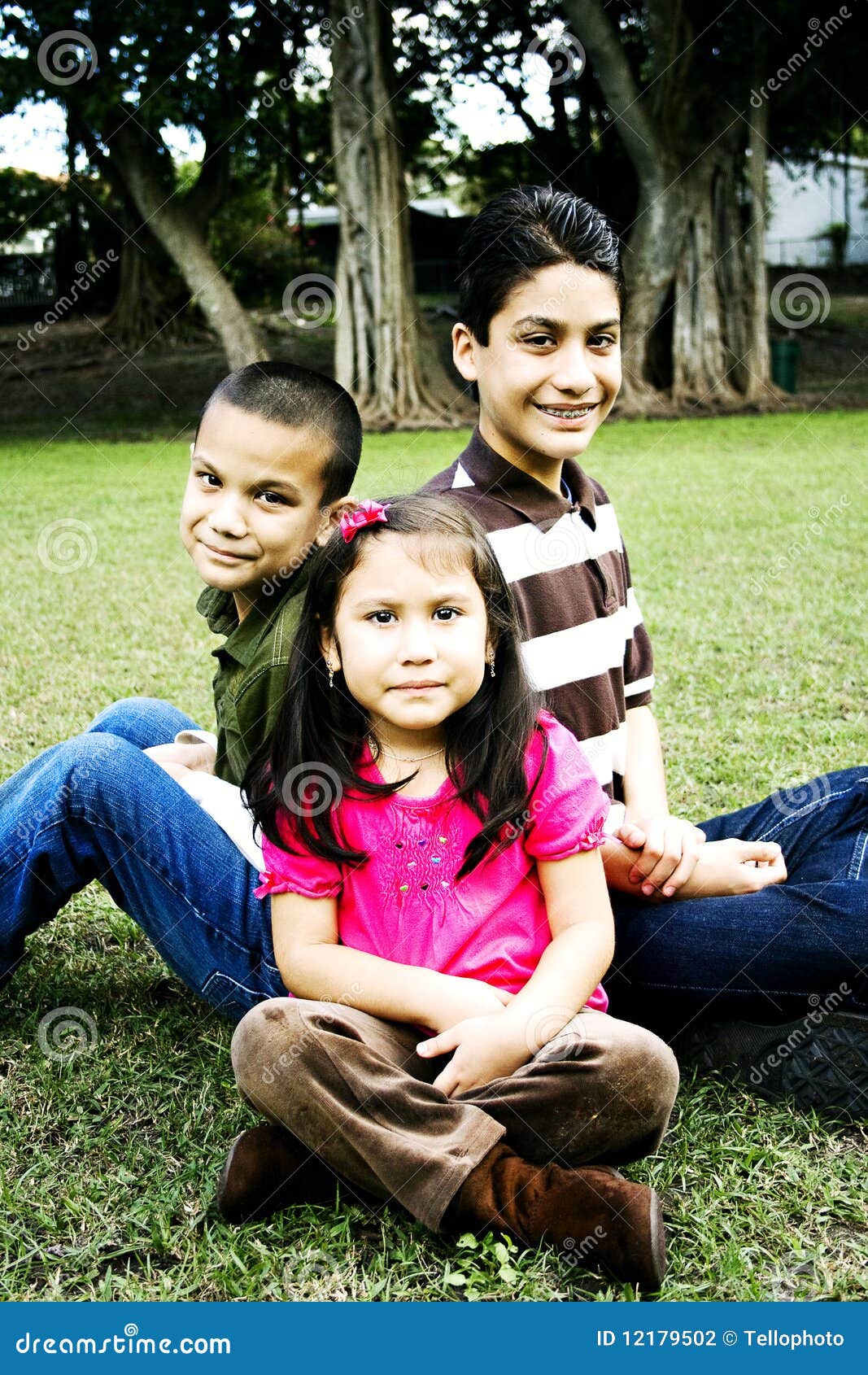 Happy Hispanic Siblings Together in Front of Tree Stock Photo - Image ...