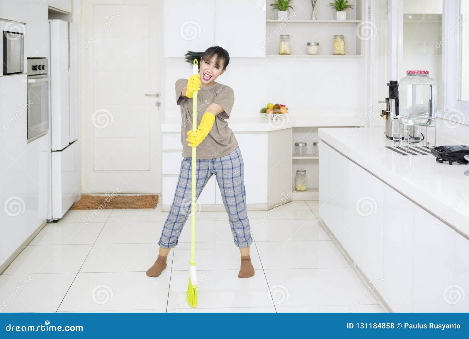 Happy Housekeeper Dancing with a Broom Stock Photo - Image of asian ...