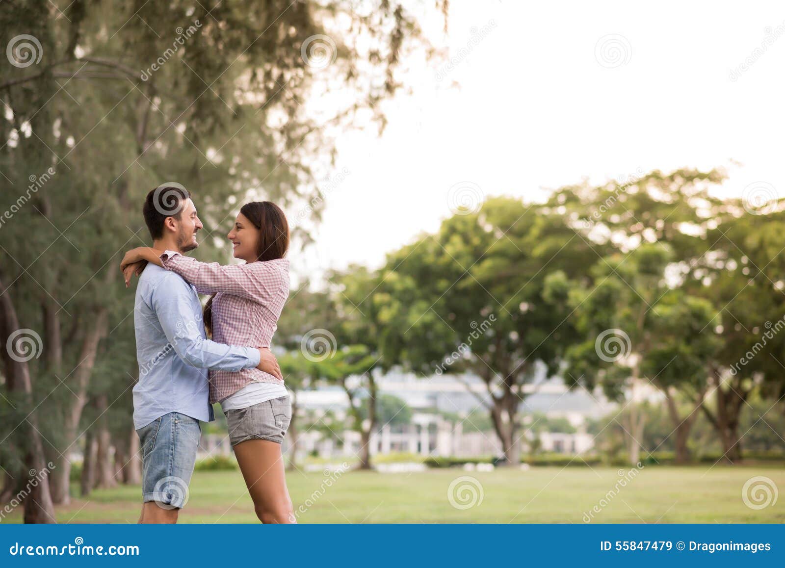 Happy hugging couple stock image. Image of sideview, young - 55847479