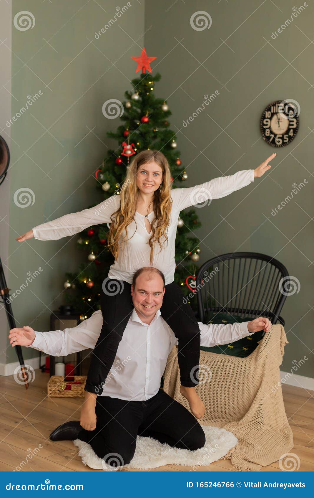 Happy Husband and Wife at the Christmas Tree at Home. Wife on Husband S ...