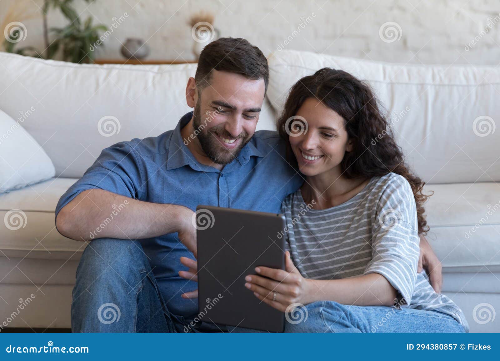 Happy Husband and Wife Sharing Tablet Computer, Enjoying Communication ...