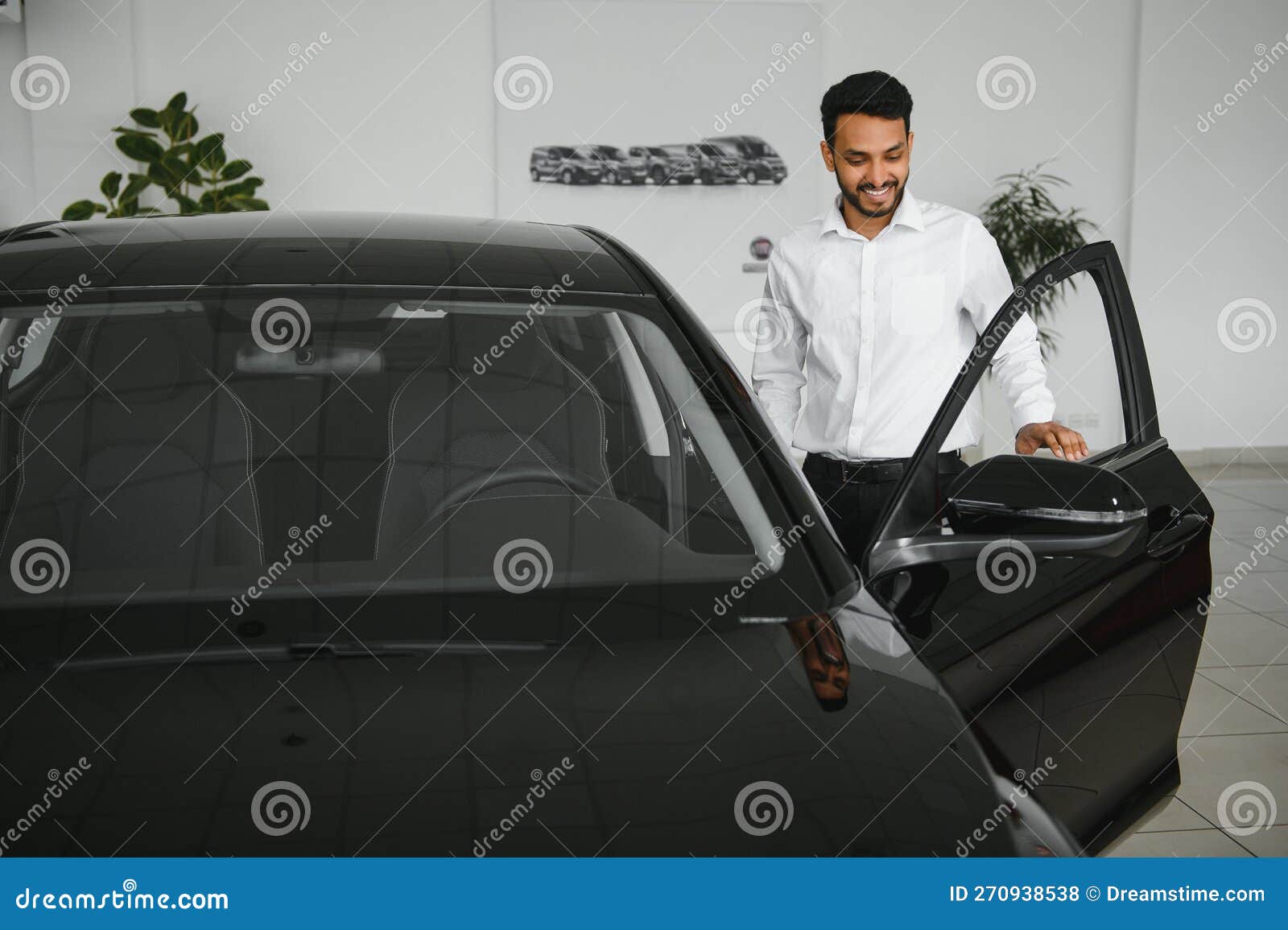 Happy Indian Man Checking Car Features at Showroom Stock Photo - Image ...