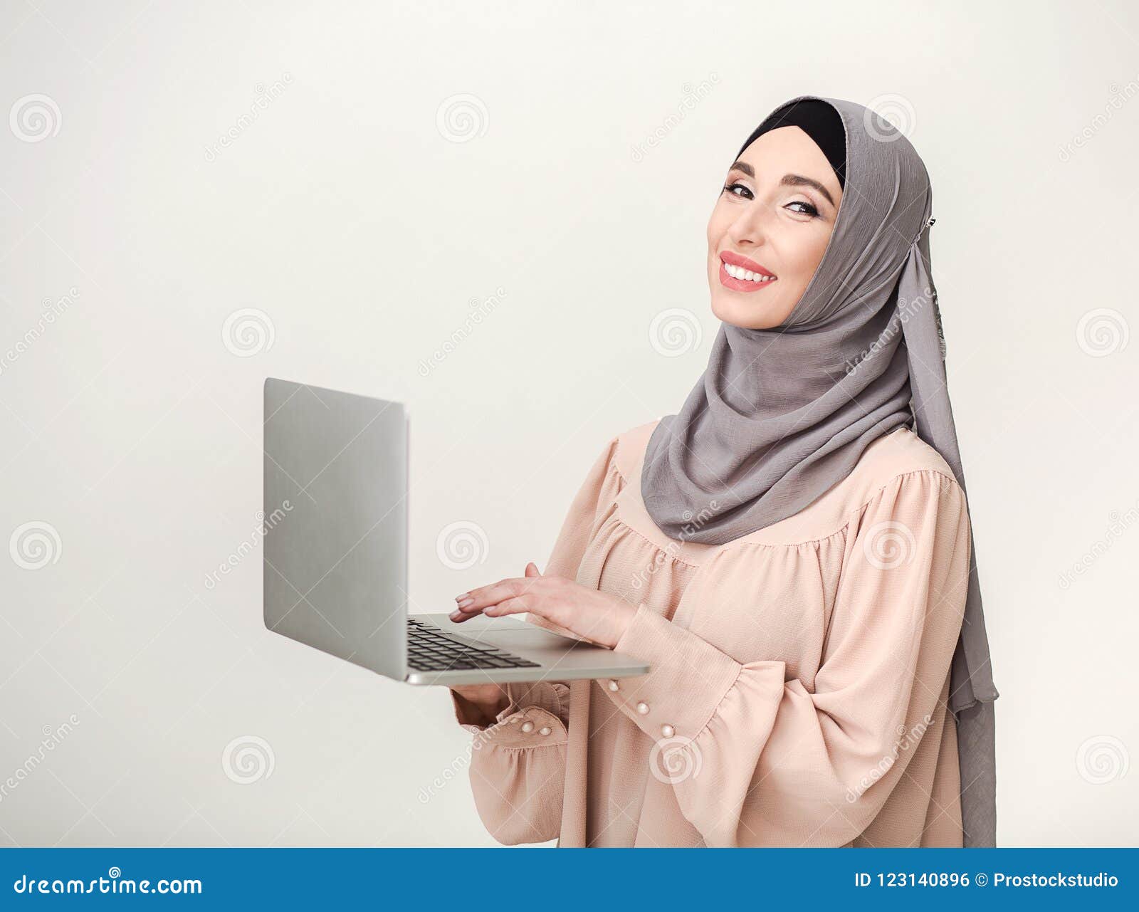 Saudi Woman Using Laptop at Studio Background Stock Photo - Image of ...