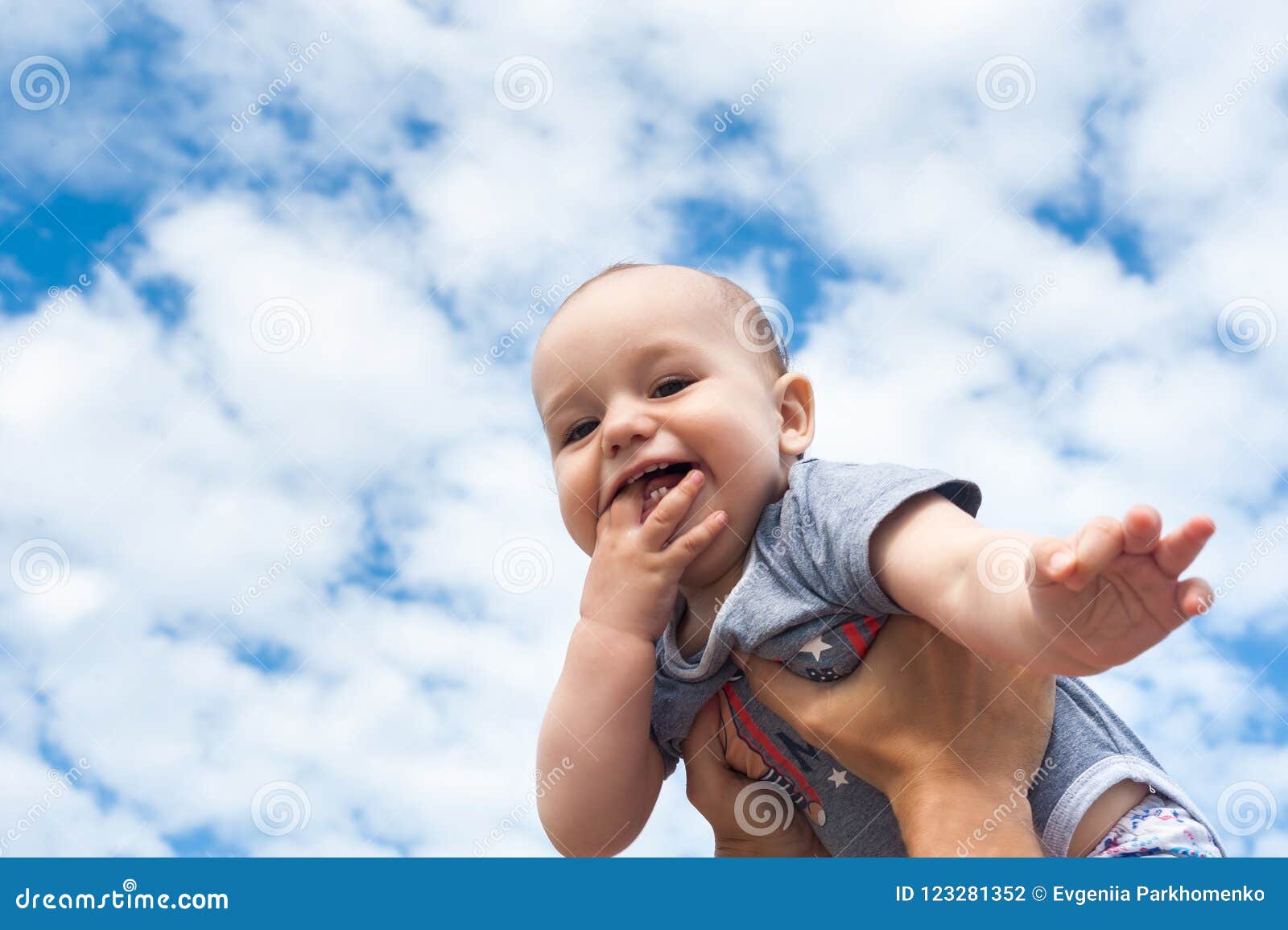 Happy Kid on a Background of Blue Sky and Clouds Stock Photo - Image of ...