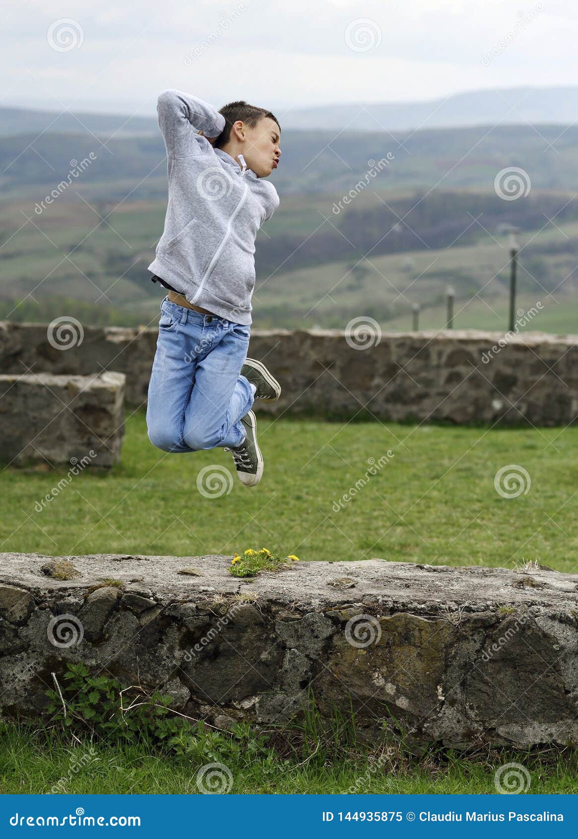 Happy kid boy jumping stock image. Image of full, hands - 144935875