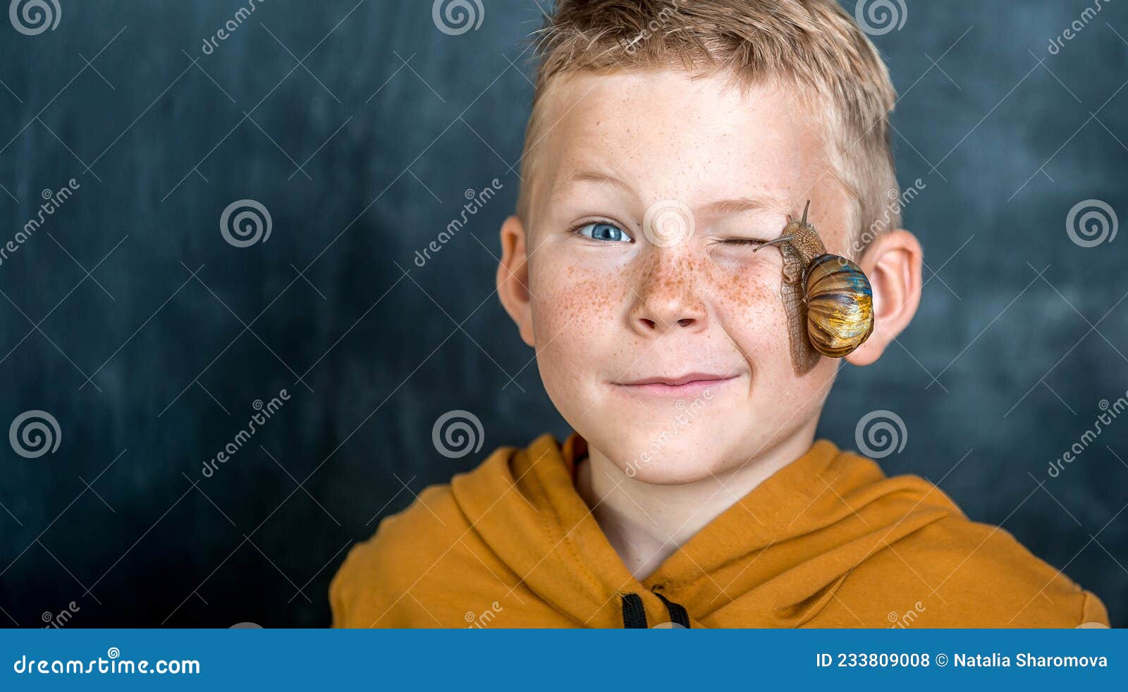 Happy Kid Boy Playing with Snail. Snail Crawling Over Face Stock Photo ...