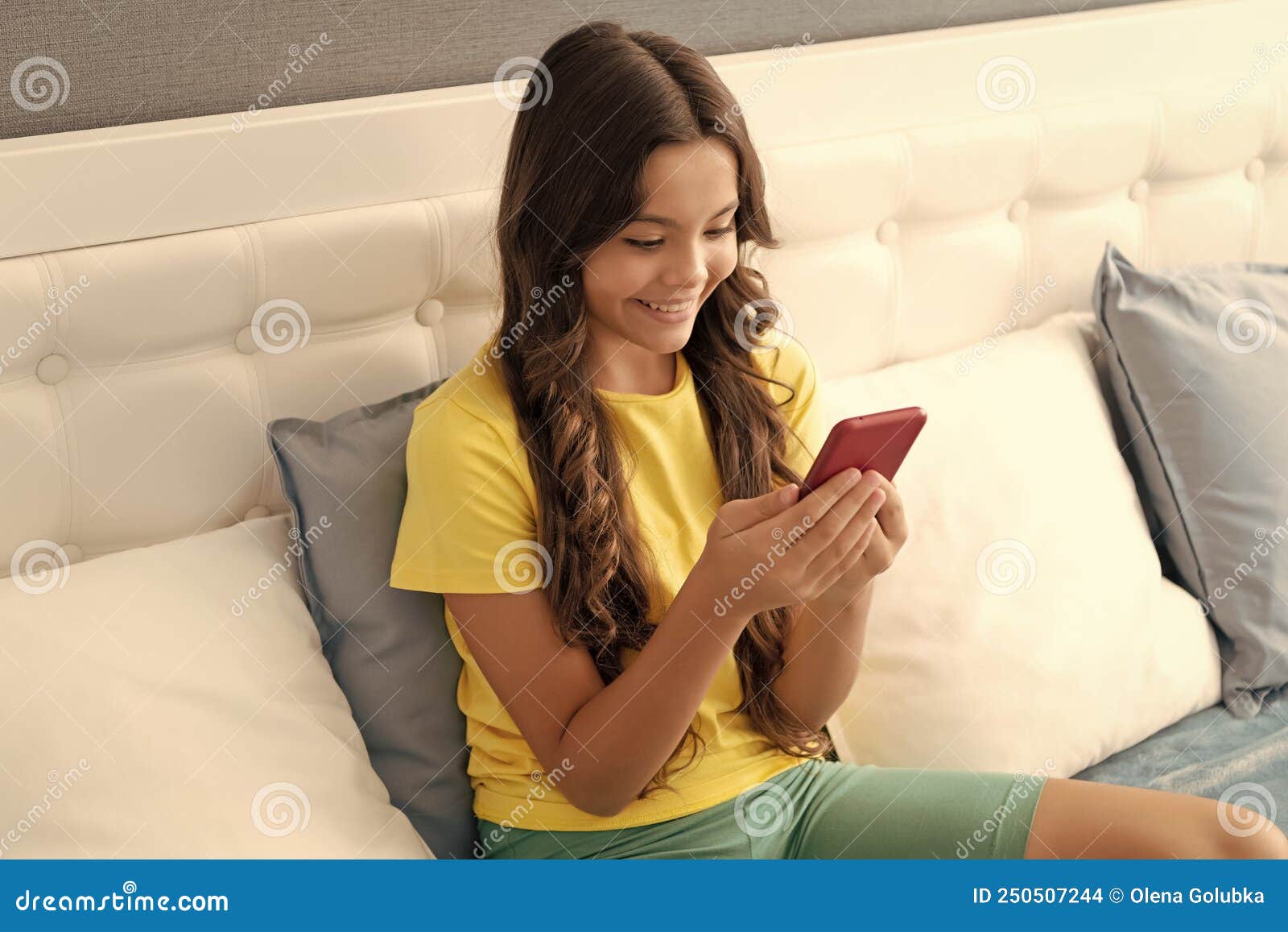 Happy Kid Chat on Mobile Phone Sitting on Bed, Chatting Stock Photo ...