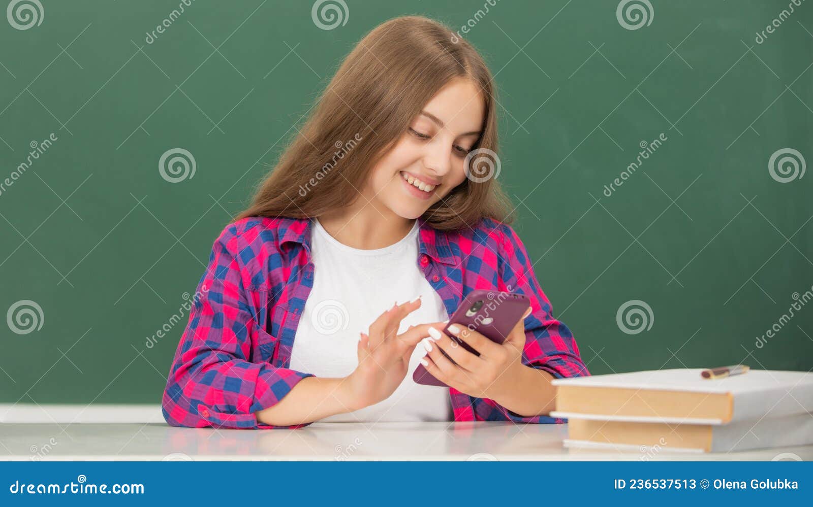 Happy Kid Chatting on Smartphone in Classroom at Blackboard ...