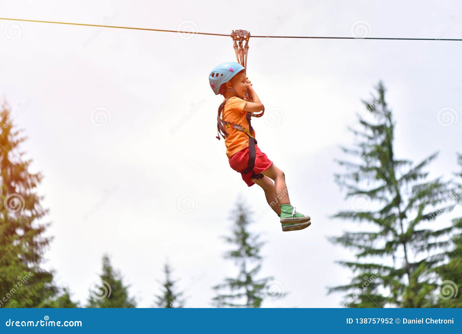Happy Kid with Helmet and Harness on Zip Line between Trees Stock Photo ...