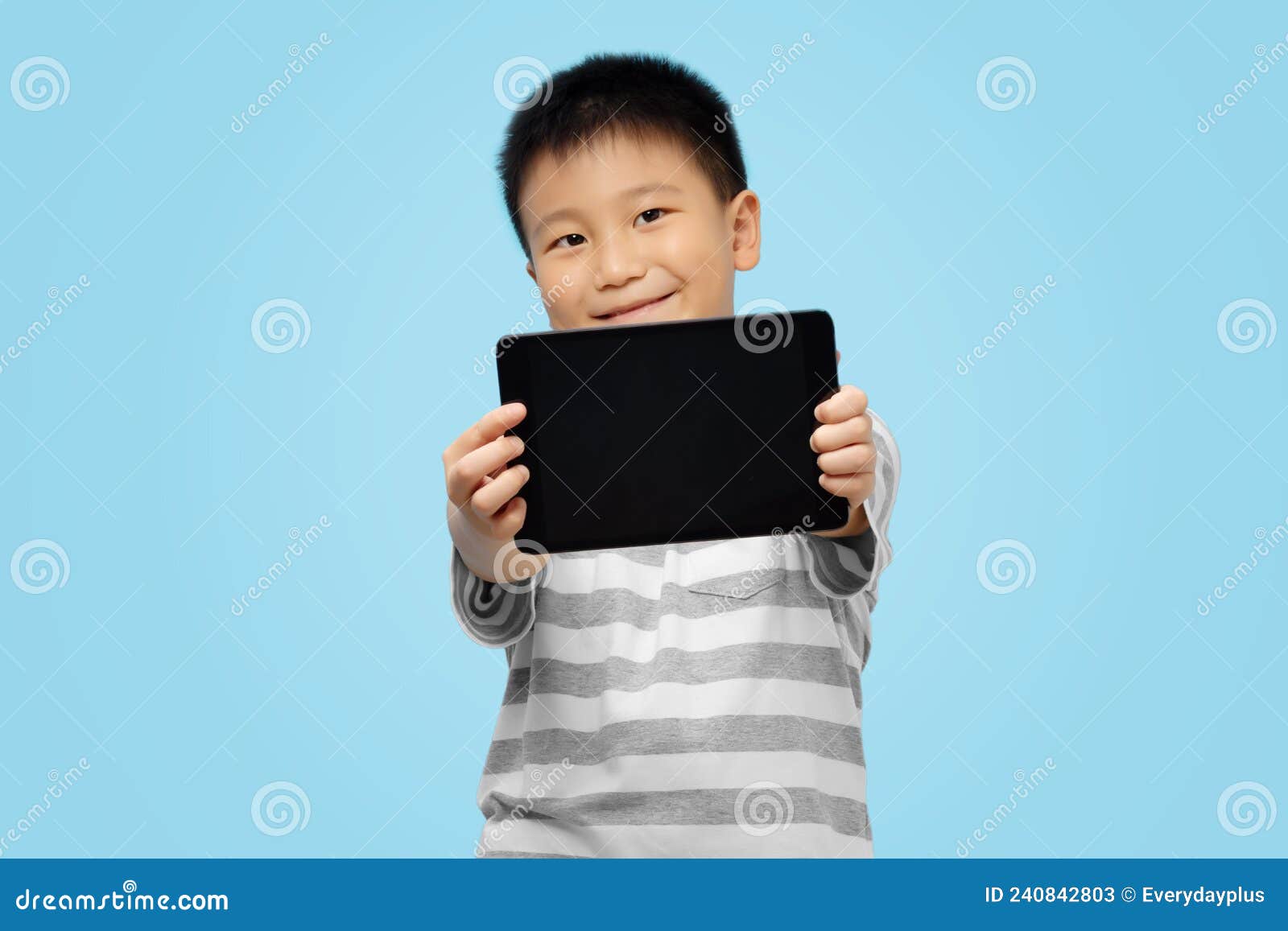 Happy Kid Holding and Showing Tablet on Blue Background Stock Image ...