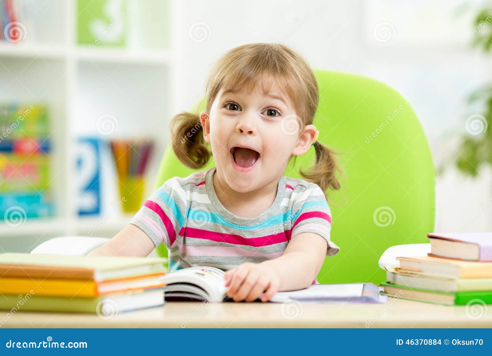 Happy Kid Reading Book at Table in Nursery Stock Photo - Image of cute ...