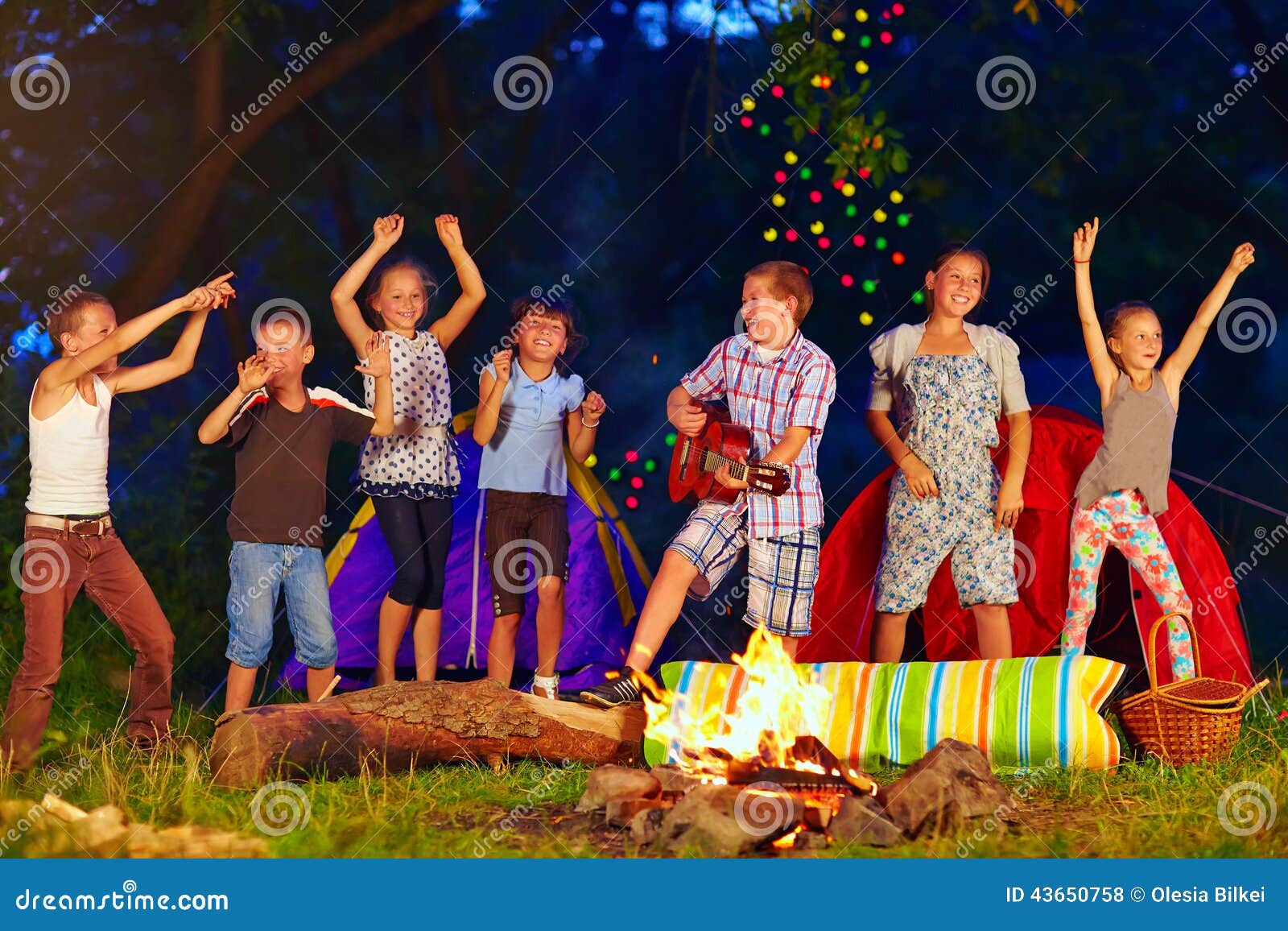 Happy Kids Dancing Around Campfire Stock Photo - Image of jump ...