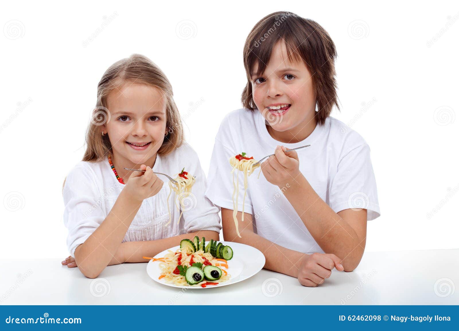 Happy kids eating pasta stock photo. Image of lunch, pasta - 62462098