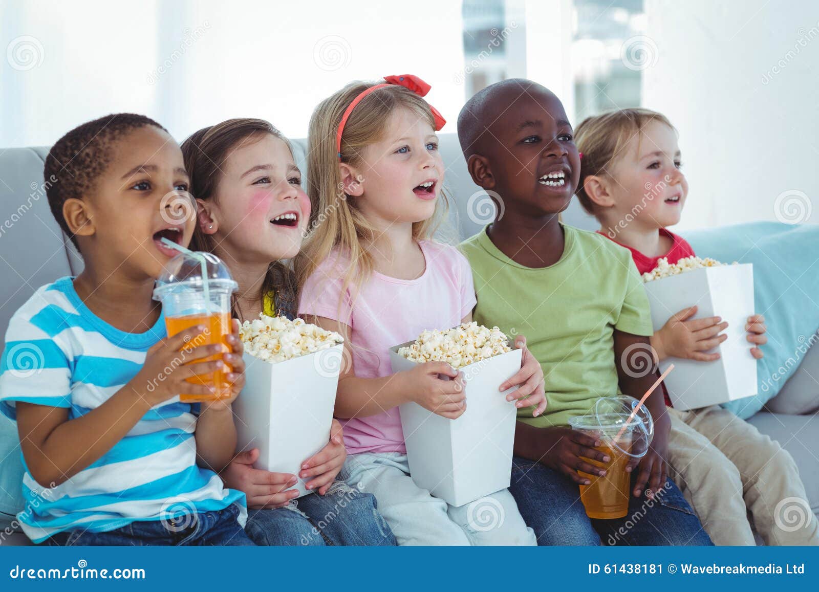 Happy Kids Enjoying Popcorn and Drinks while Sitting Stock Image ...