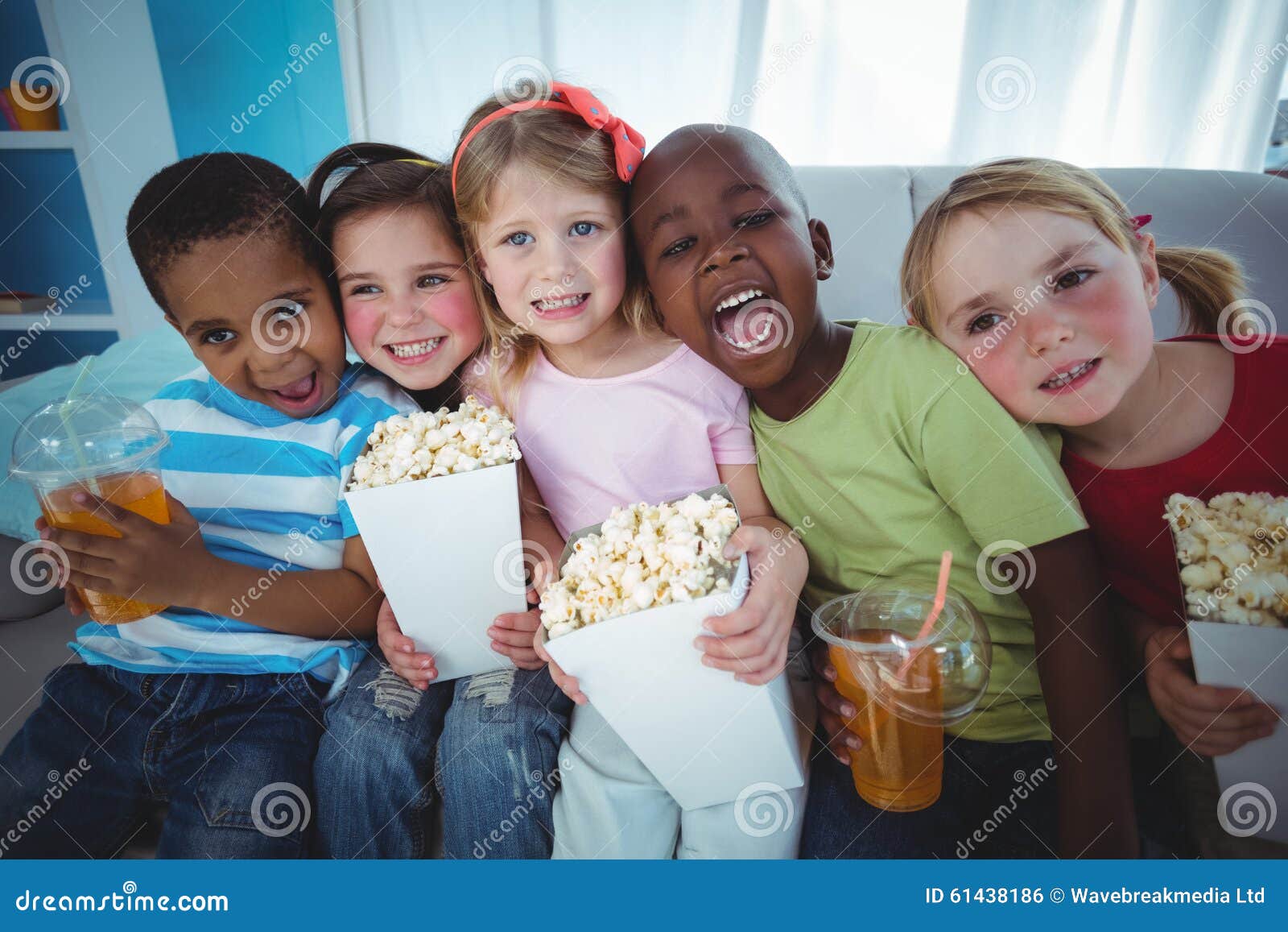 Happy Kids Enjoying Popcorn and Drinks while Sitting Stock Photo ...