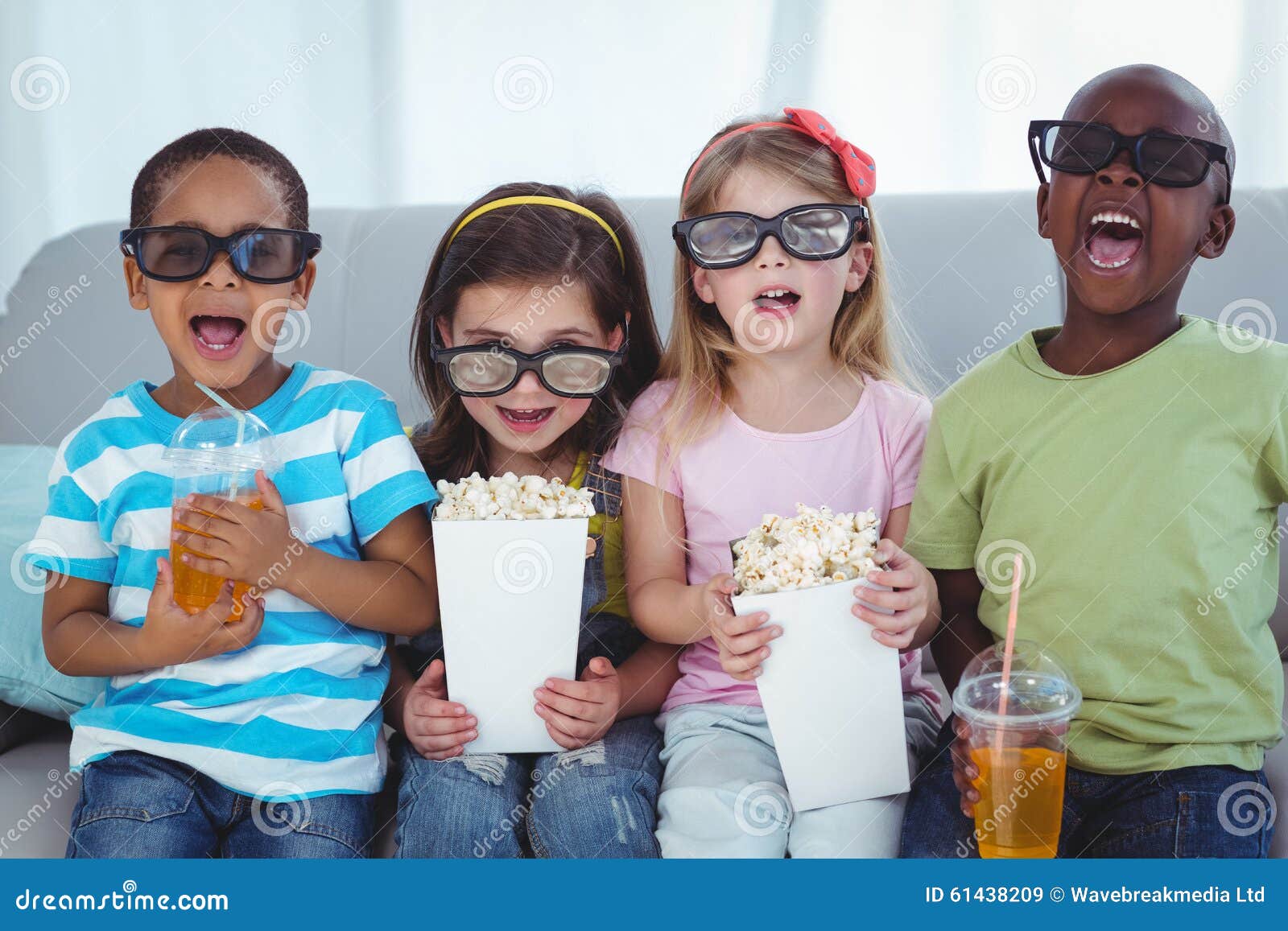 Happy Kids Enjoying Popcorn and Drinks while Sitting Stock Image ...