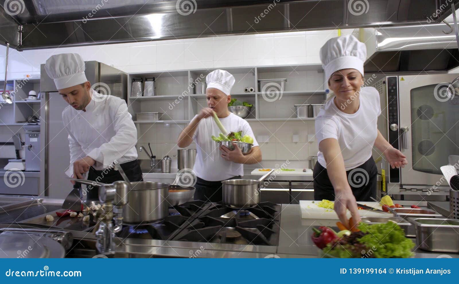 Happy Kitchen Crew with Chef Singing and Dancing while Cooking Stock ...