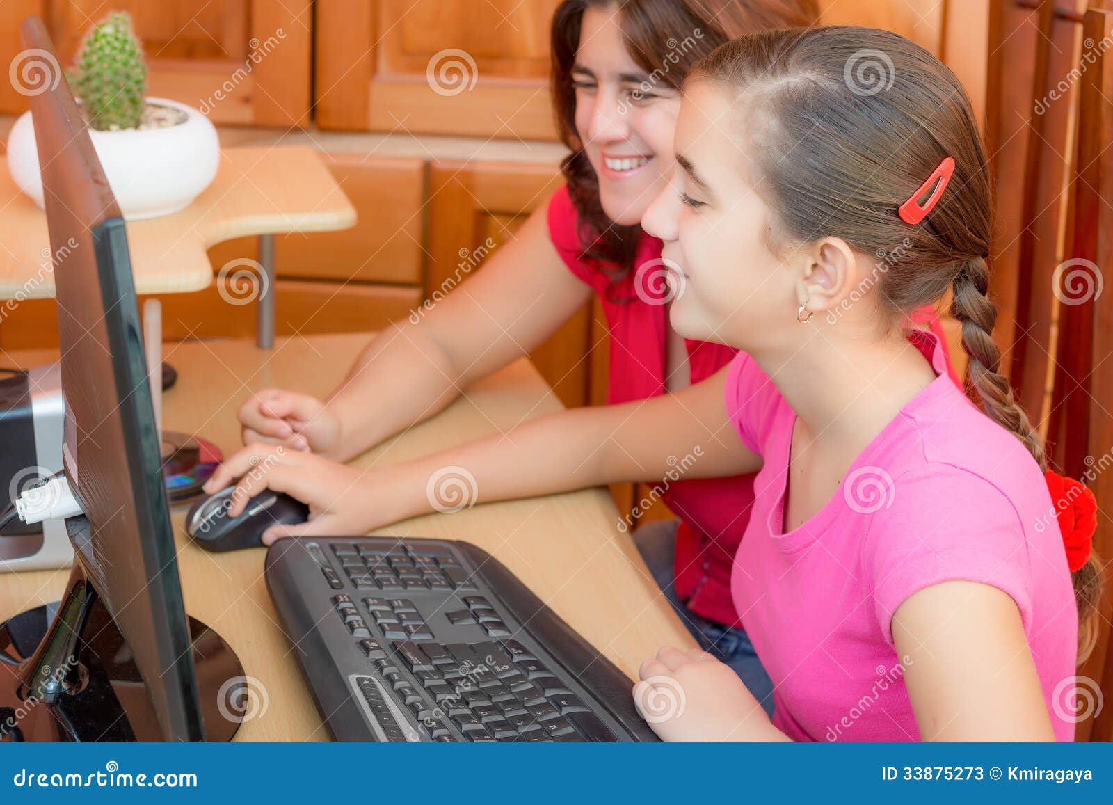 Happy Latin Girl and Her Young Mother Working on a Computer Stock Image ...