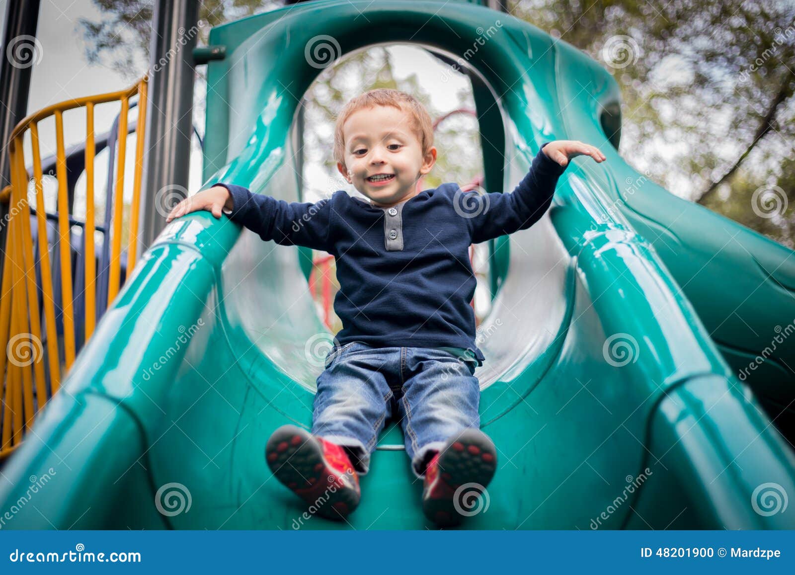 Happy Little Boy on the Playground Slide Stock Photo - Image of ...