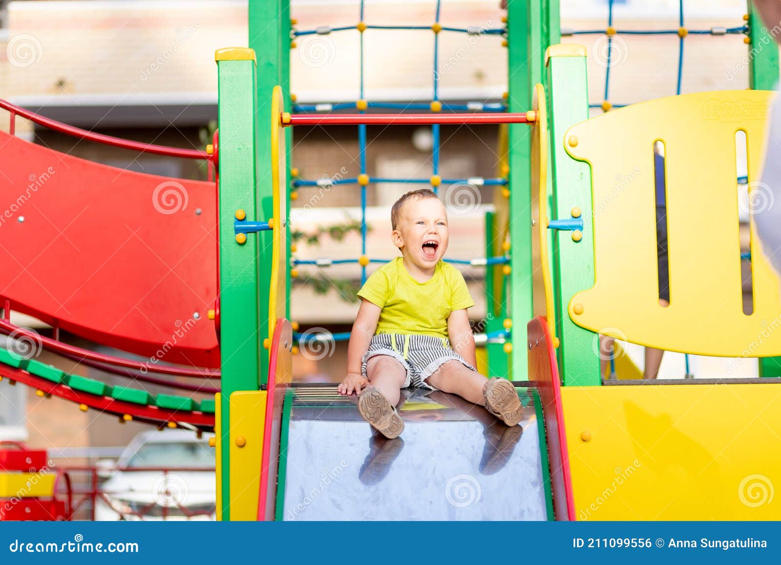 Happy Little Boy Rolling Down the Hill on the Playground Stock Photo ...