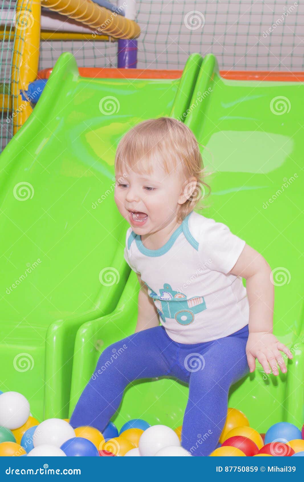 Happy Little Boy Rolling Down the Hill on the Playground Stock Image ...