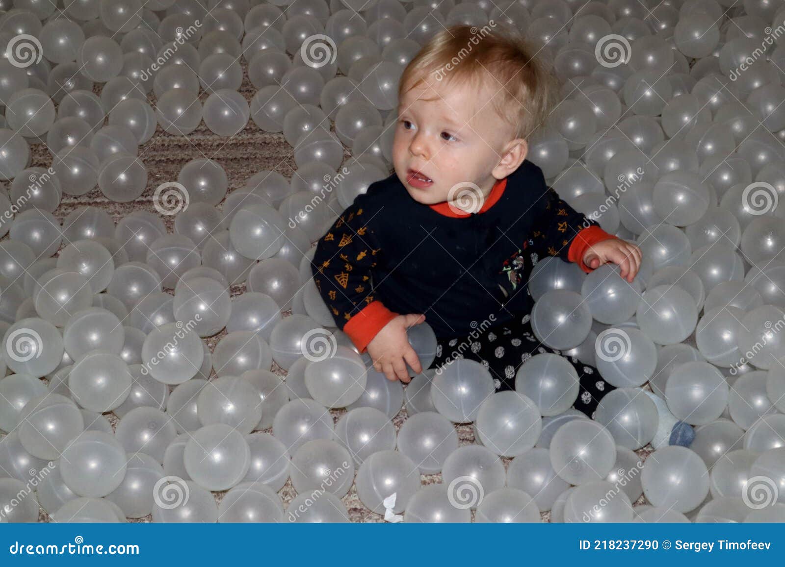 Happy Little Child Playing with Plastic Bubbles in the Pool Stock Photo ...