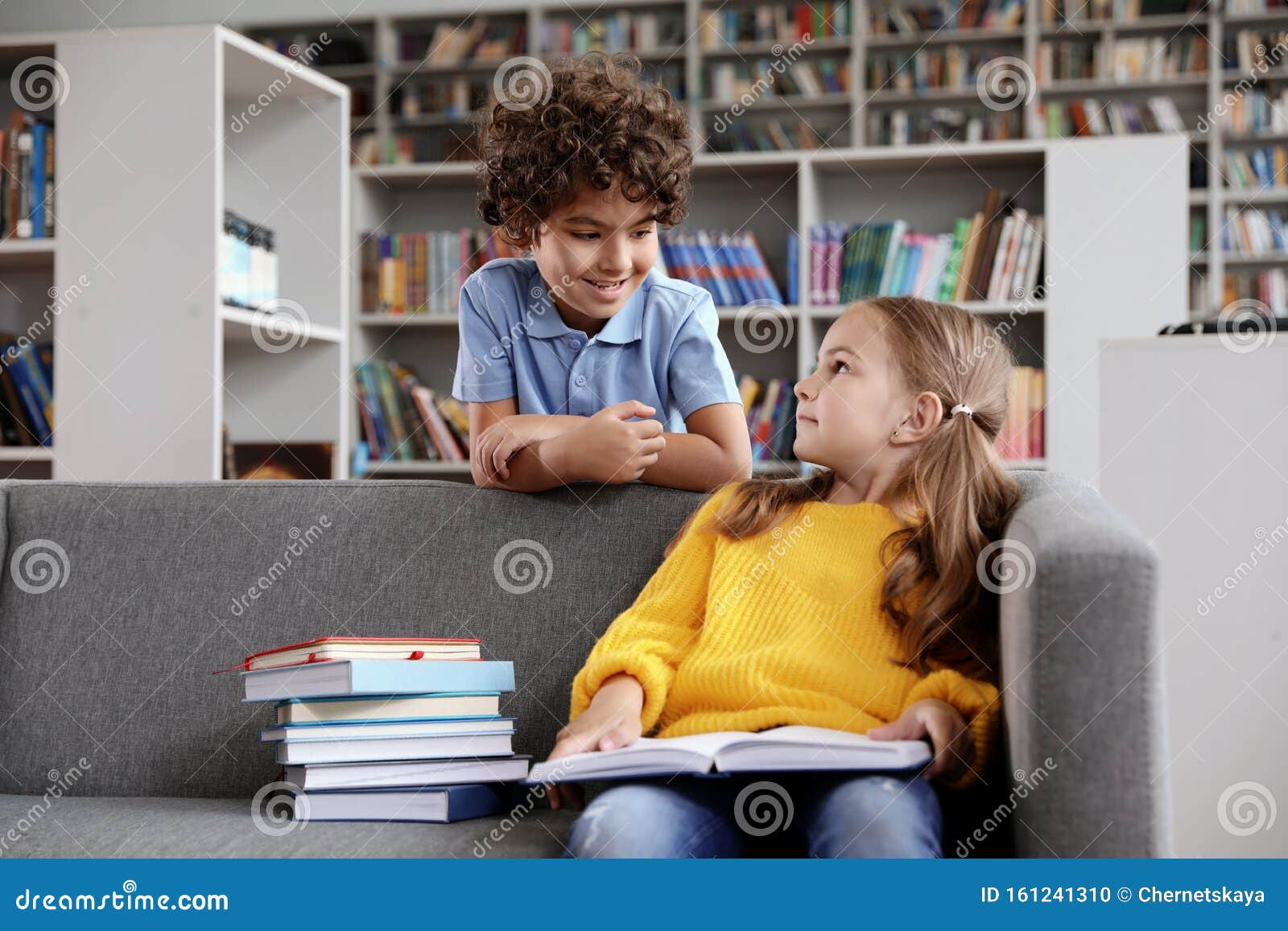 Happy Little Children Reading Book on Sofa Stock Photo - Image of ...