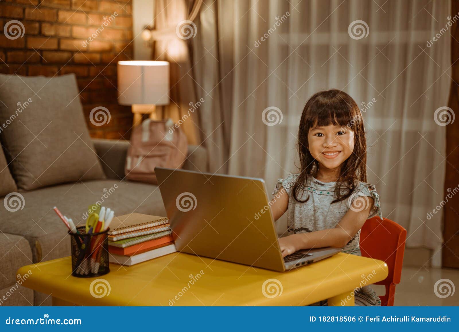 Happy Little Girl Doing Homework Using Laptop Stock Photo - Image of ...