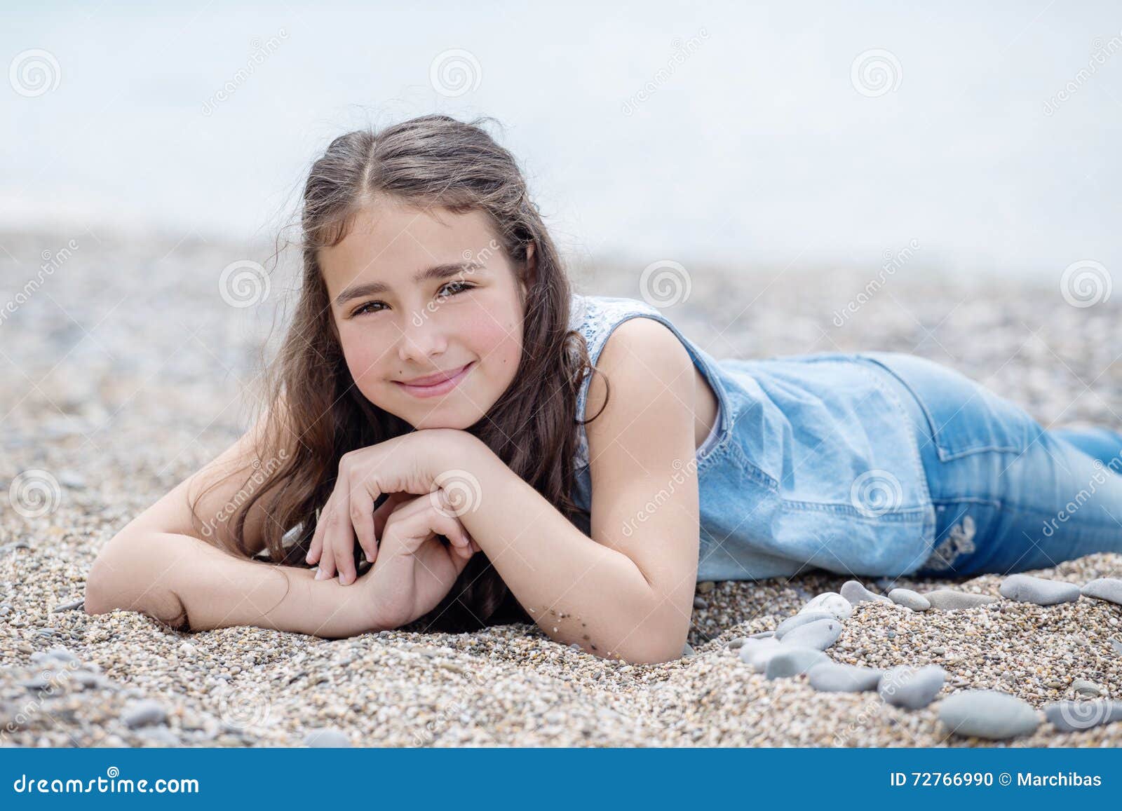 Happy Little Girl Lying on the Beach Stock Photo - Image of pebbles ... Happy Little Girl Lying on the Beach Stock Photo - Image of pebbles ...