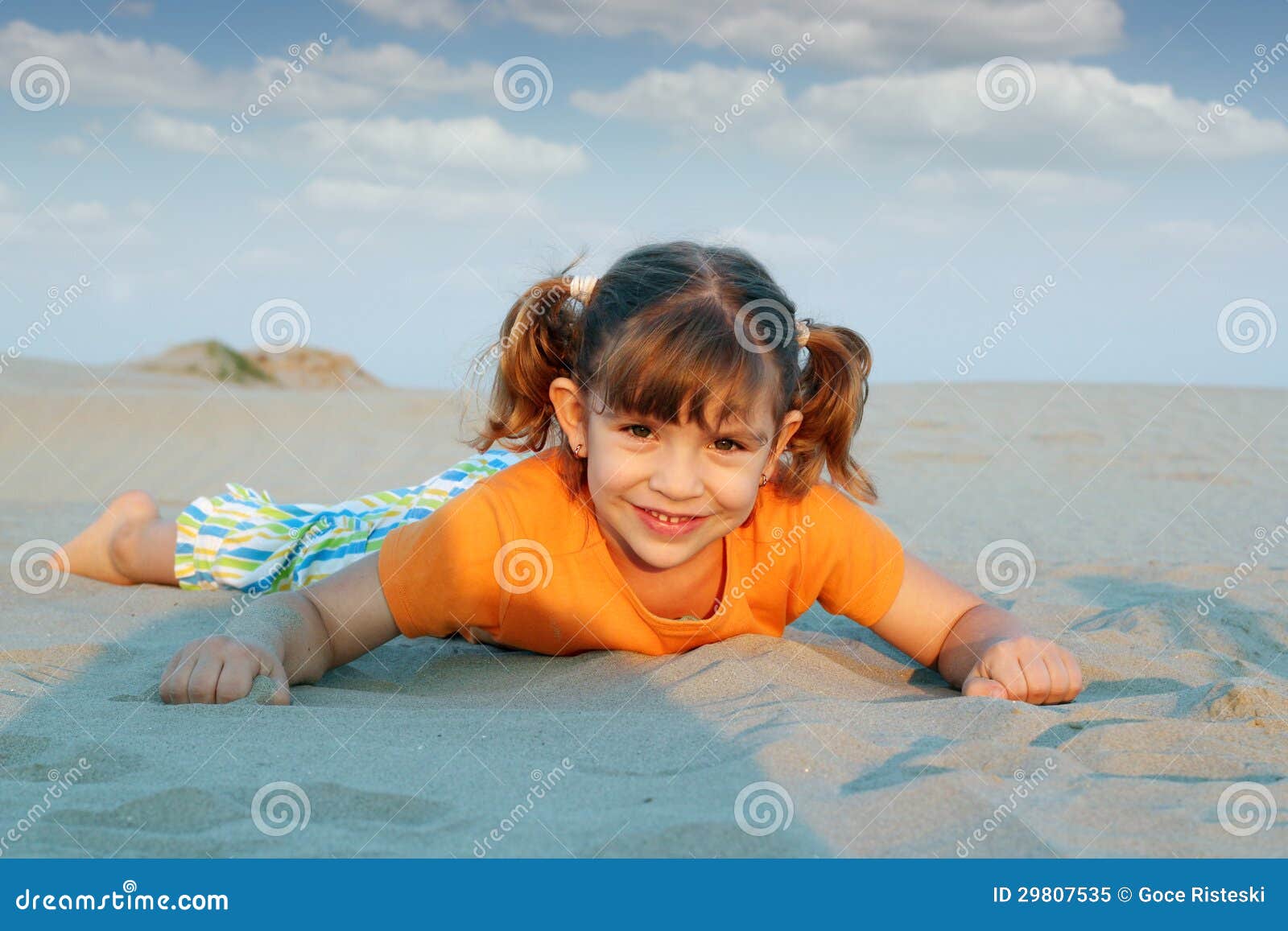 Little girl lying on sand stock image. Image of summer - 29807535