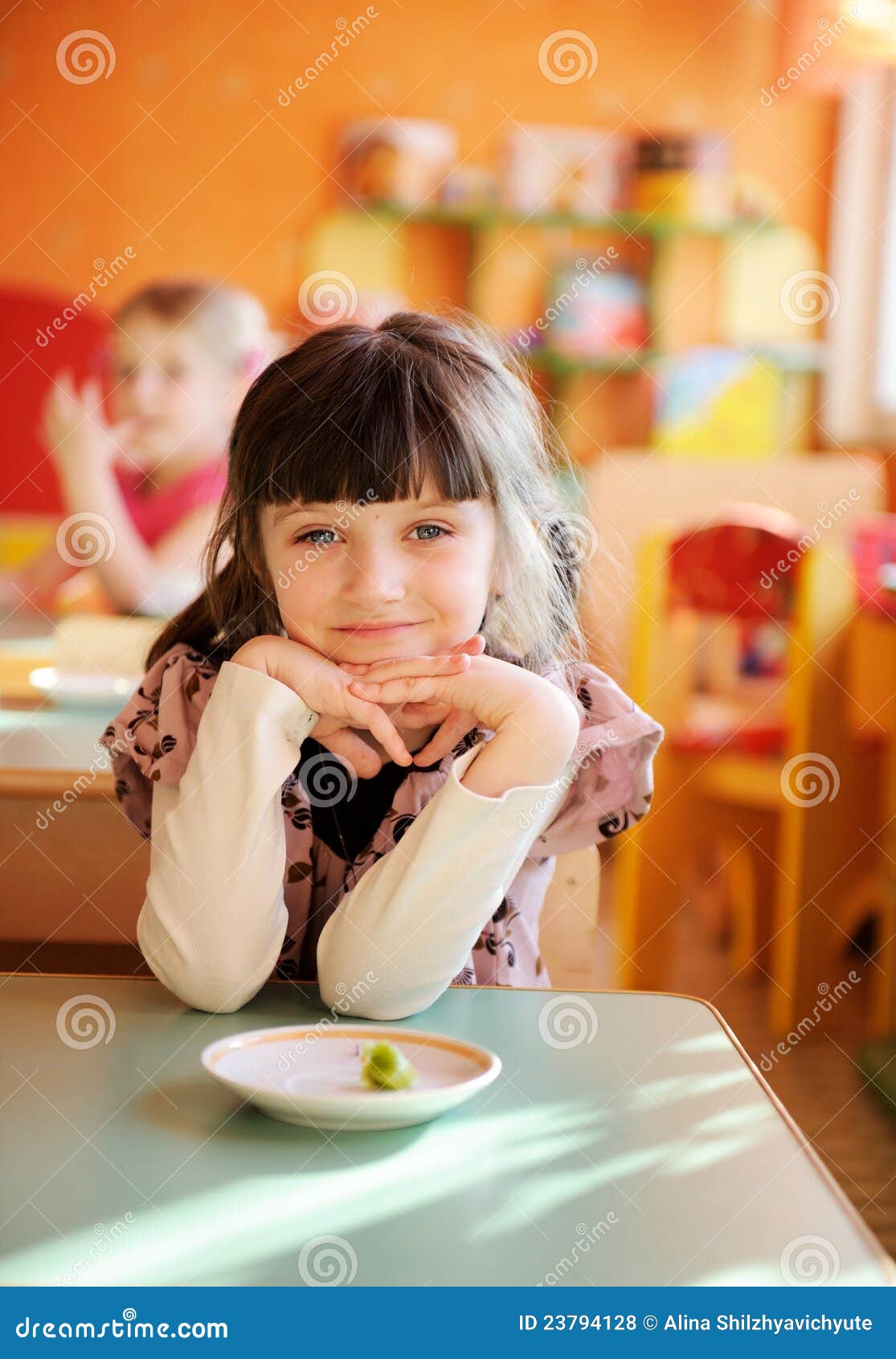 Happy Little Girl Sitting at a Table Stock Photo - Image of brunette ...