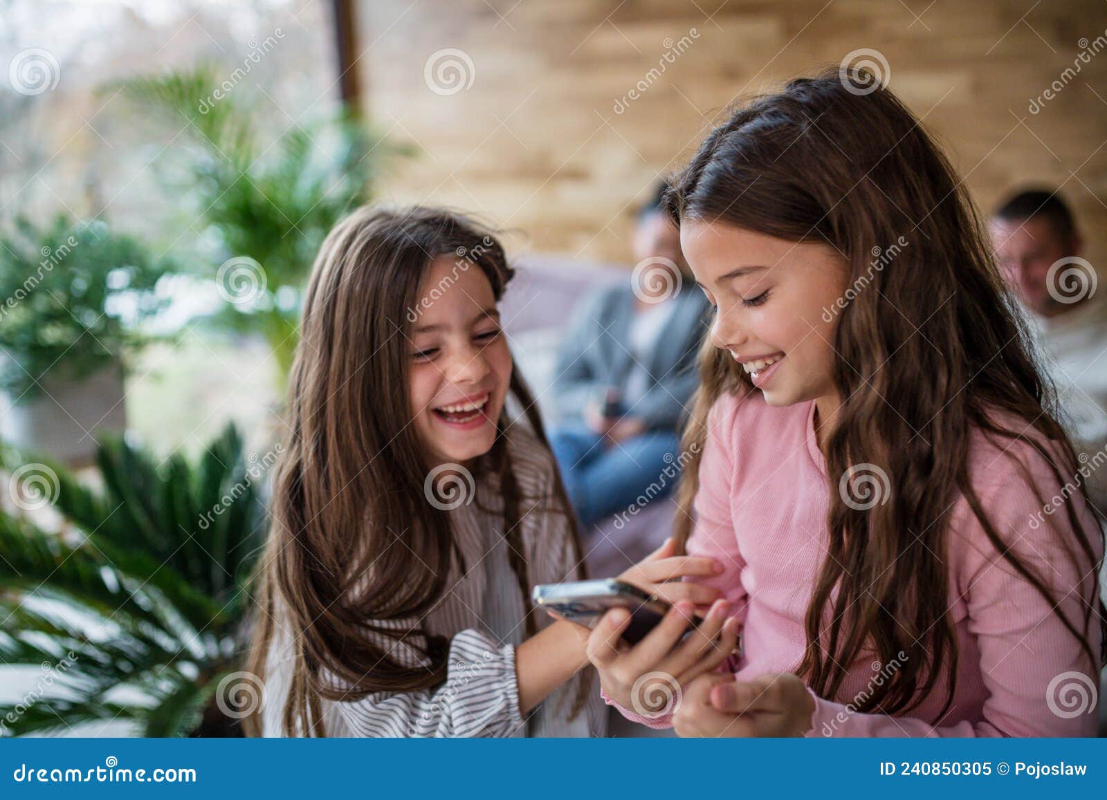 Happy Little Sisters Using Smartphone at Home. Stock Image - Image of ...