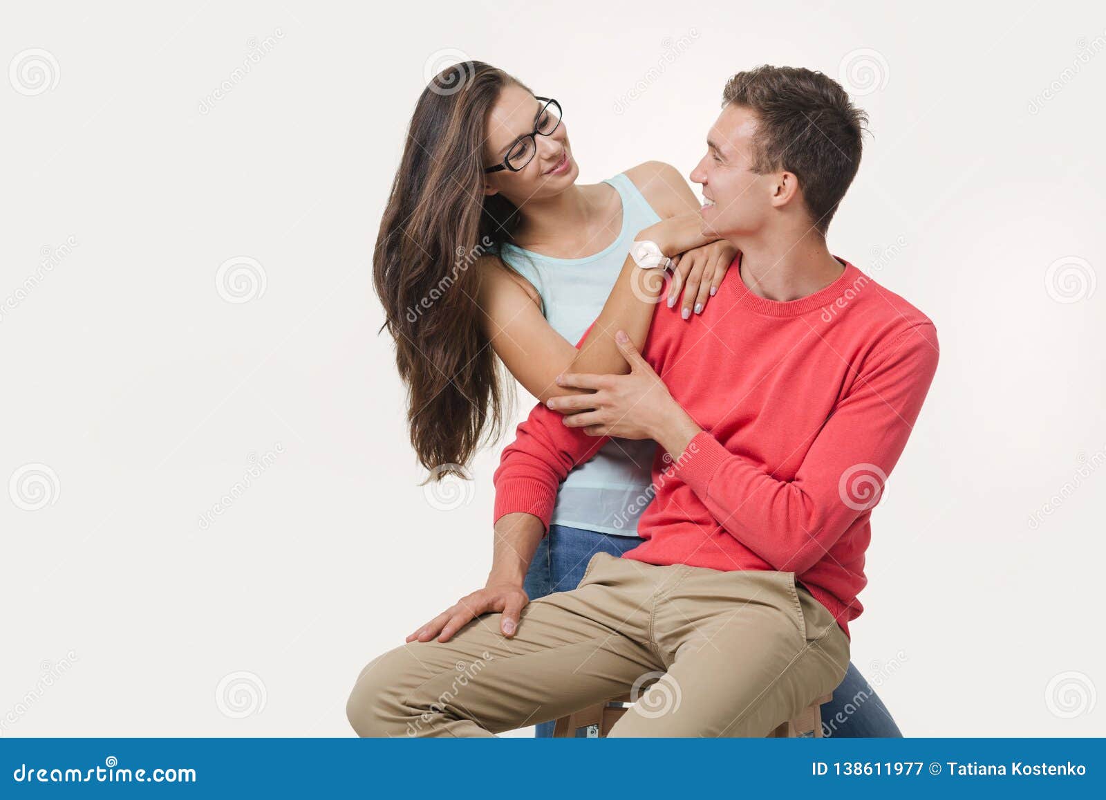 Happy Lovely Couple Hugging And Smiling Looking Each To Other On White