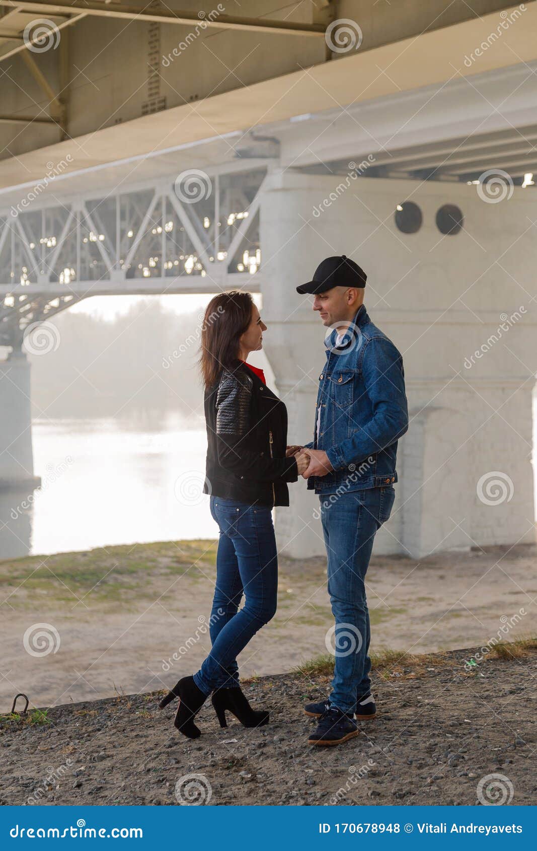 Happy Lovers Stand Under the Bridge on a Sunny Day. Stock Photo - Image ...