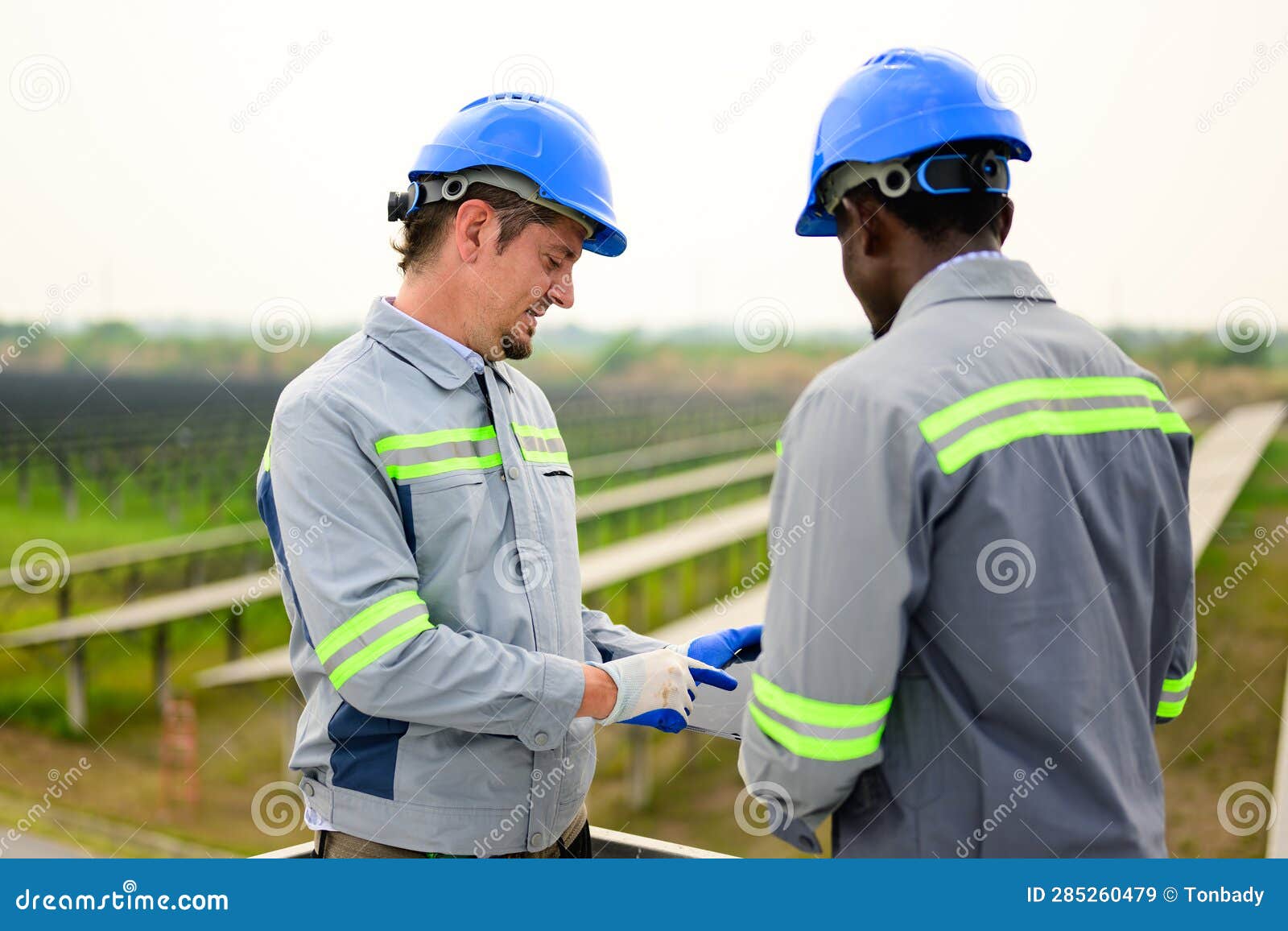 Happy Maintenance Engineers Checking and Maintaining Solar Panels Stock ...