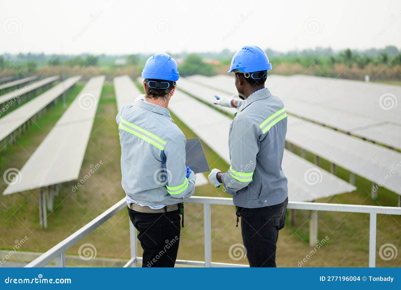 Happy Maintenance Engineers Checking and Maintaining Solar Panels Stock ...