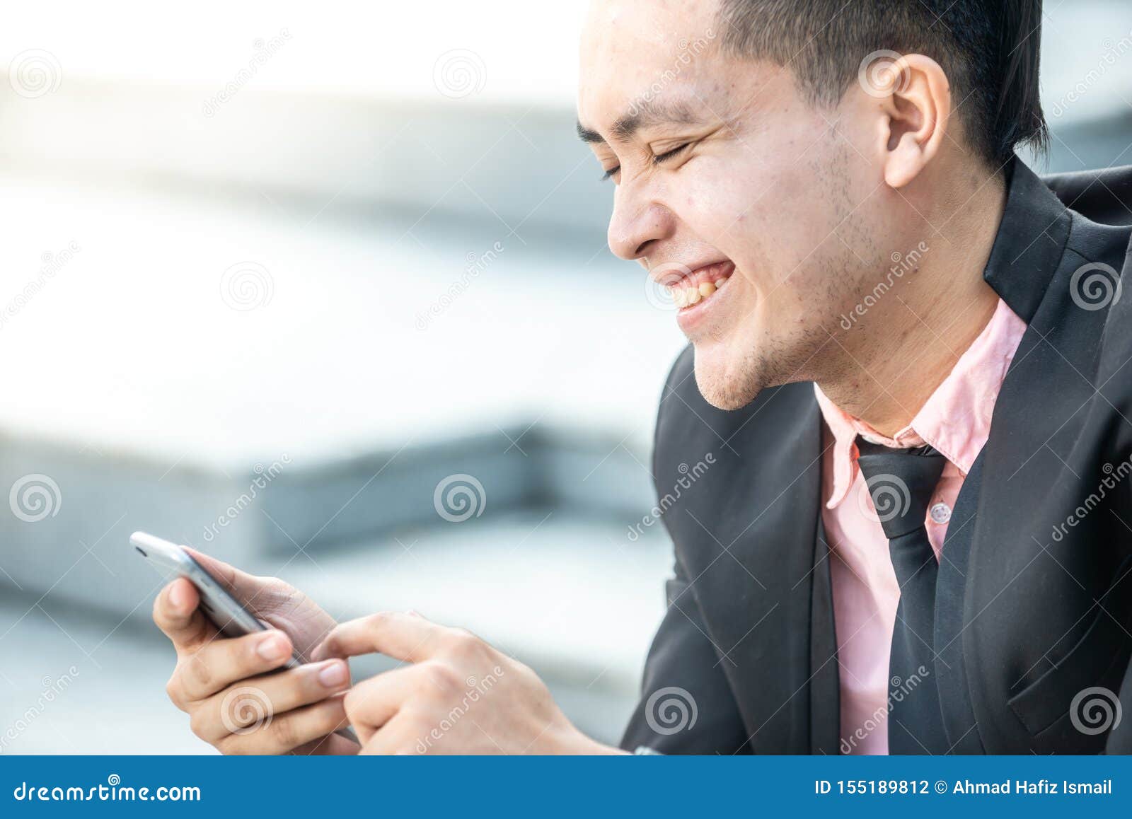 Happy Malay Businessman Looking at His Smartphone Stock Photo - Image ...