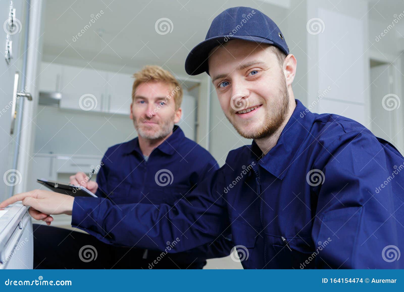 Happy Male Plumber Working with Teacher Stock Photo - Image of ...