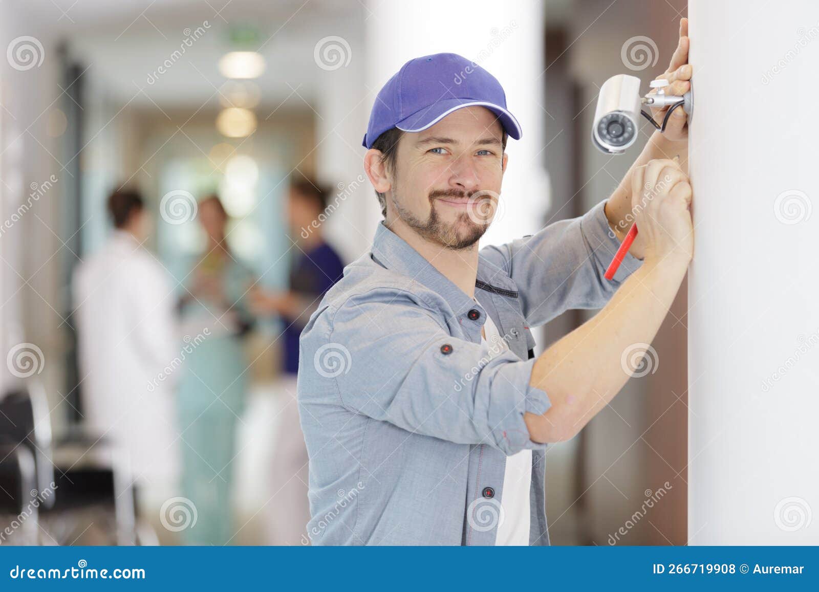 Happy Male Technician Fixing Cctv Camera Inside Hospital Stock Photo ...