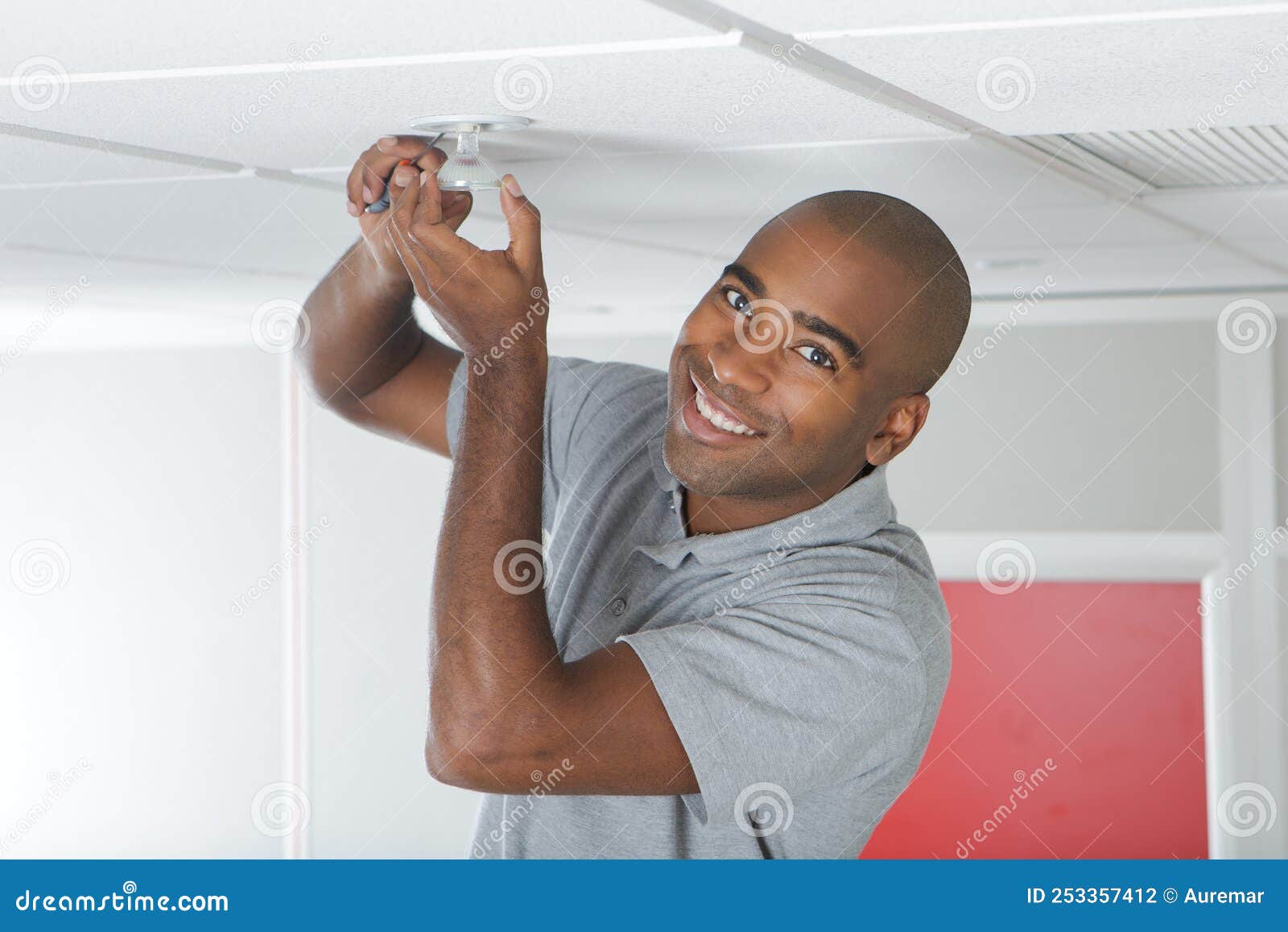 Happy Male Worker Changing Light Bulb Stock Photo - Image of electrical ...