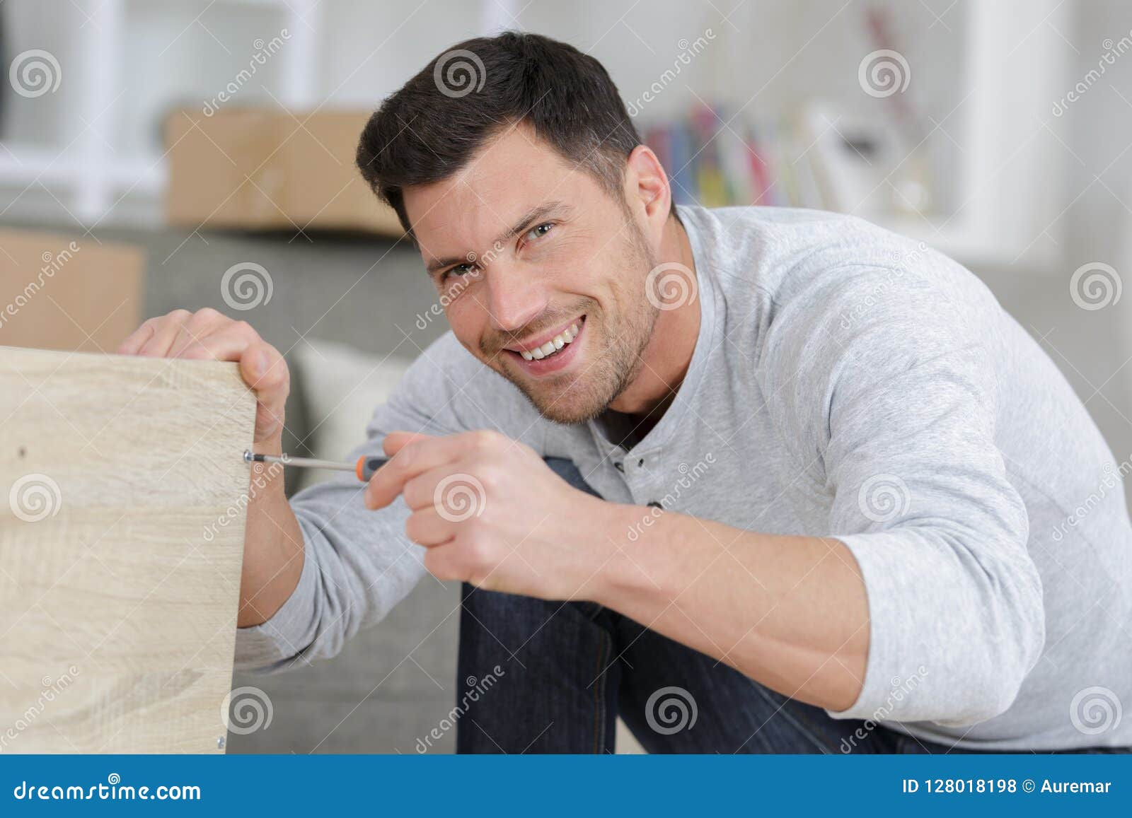 Happy Man Assembling Furniture at Home Stock Photo - Image of house ...