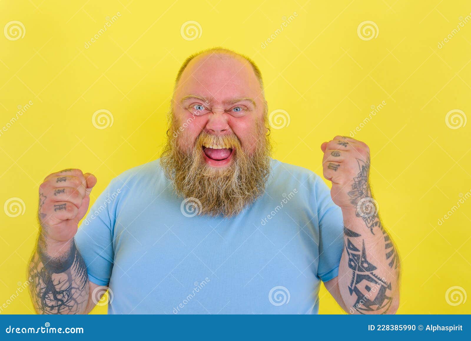 Happy Man with Beard and Tattoos Does a Winning Gesture with Hands ...
