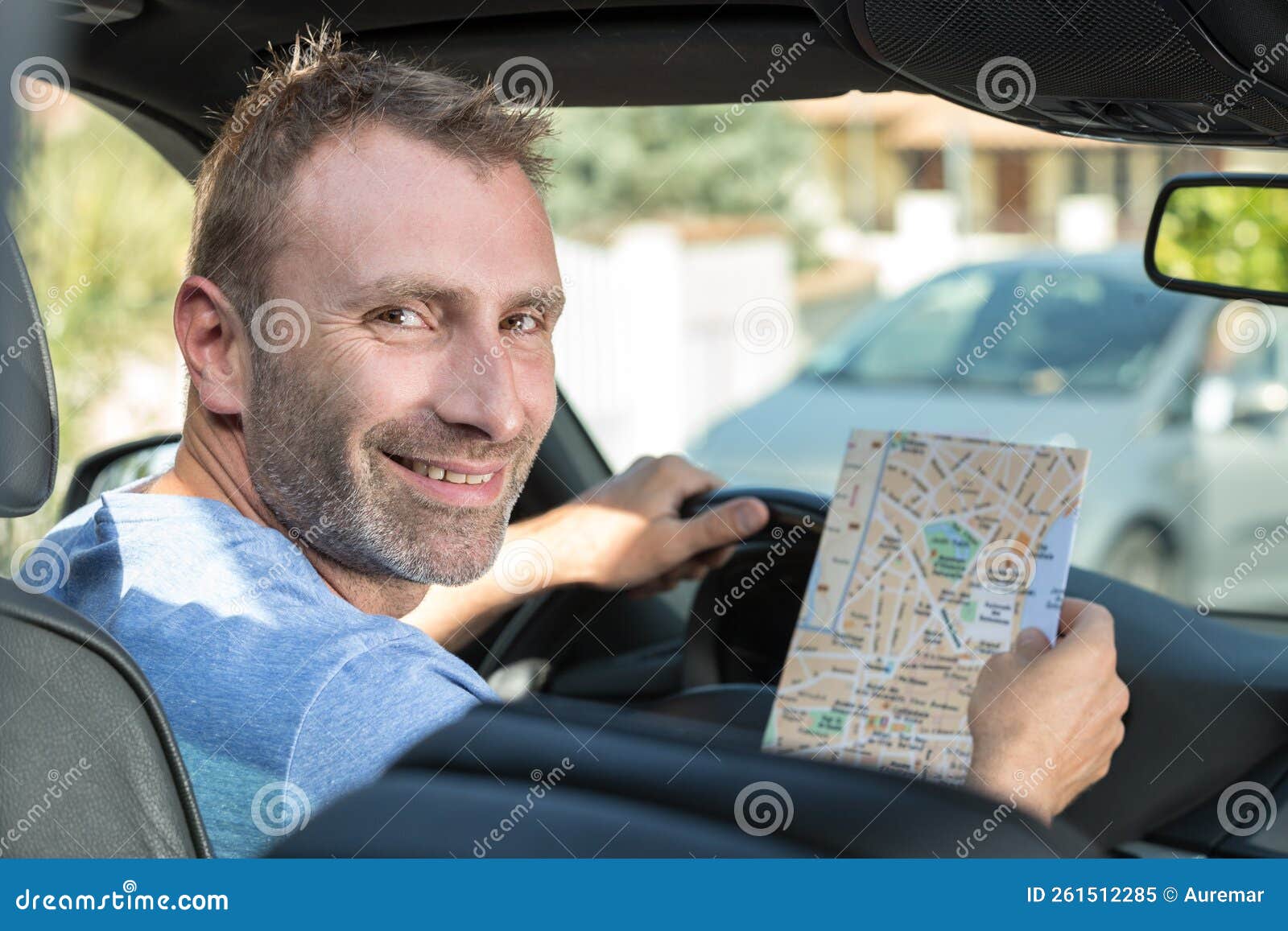 Happy man in car with map stock image. Image of outdoors - 261512285